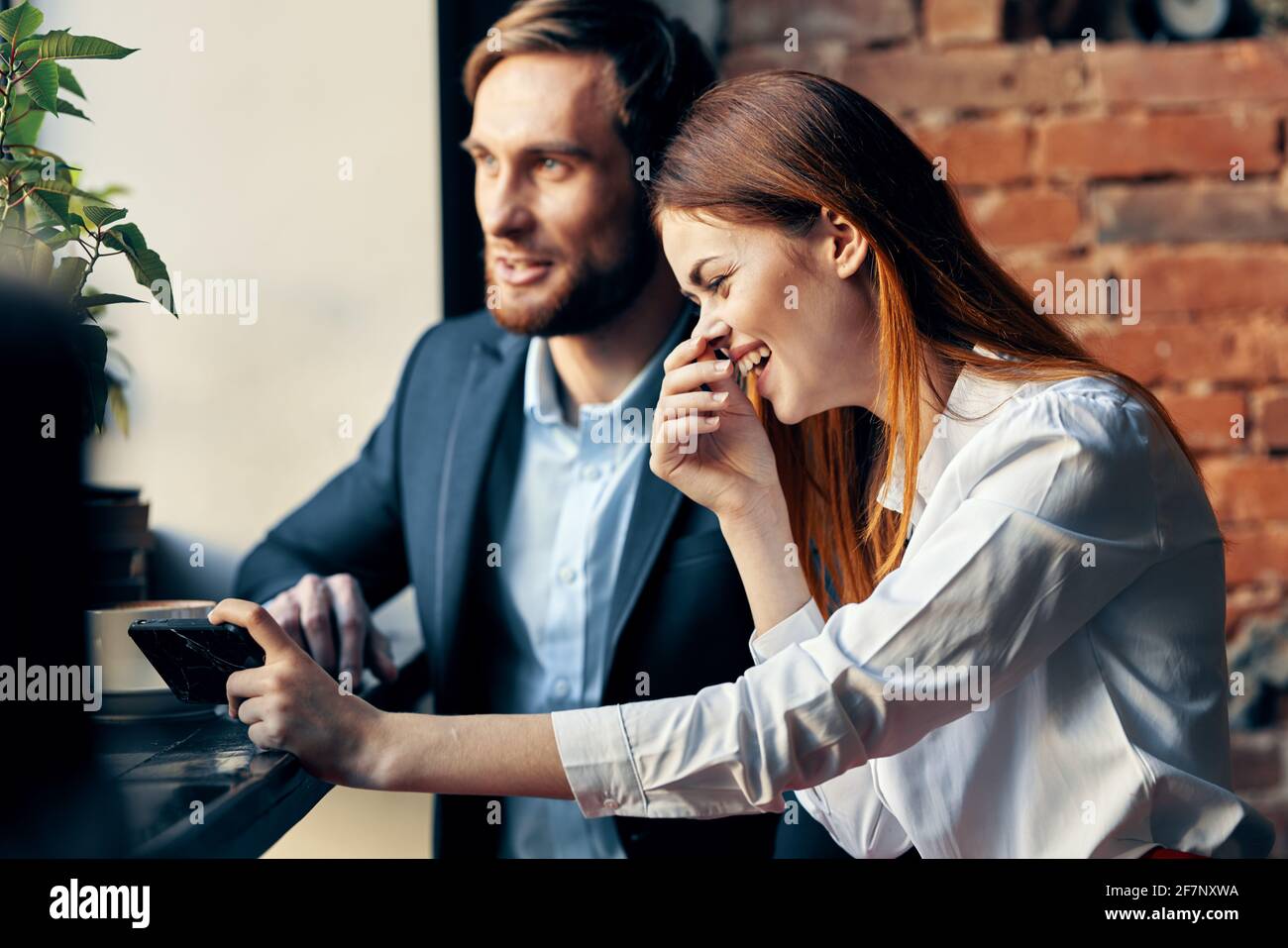 Cheerful man and woman work colleagues socializing in cafe lifestyle ...
