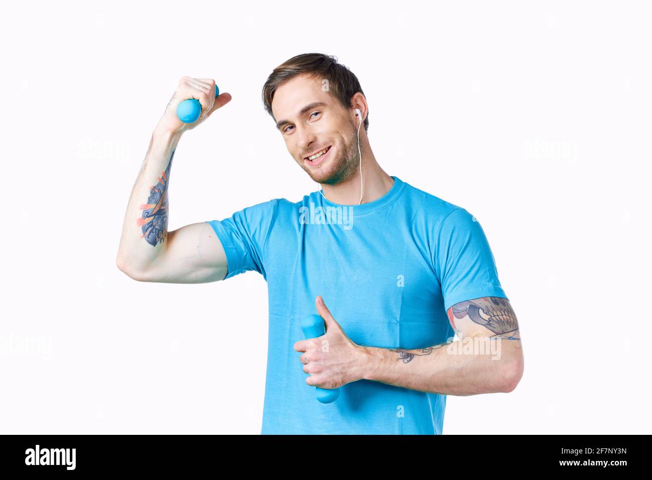 man with dumbbells pumped up arm muscles smile model tattoo blue t ...