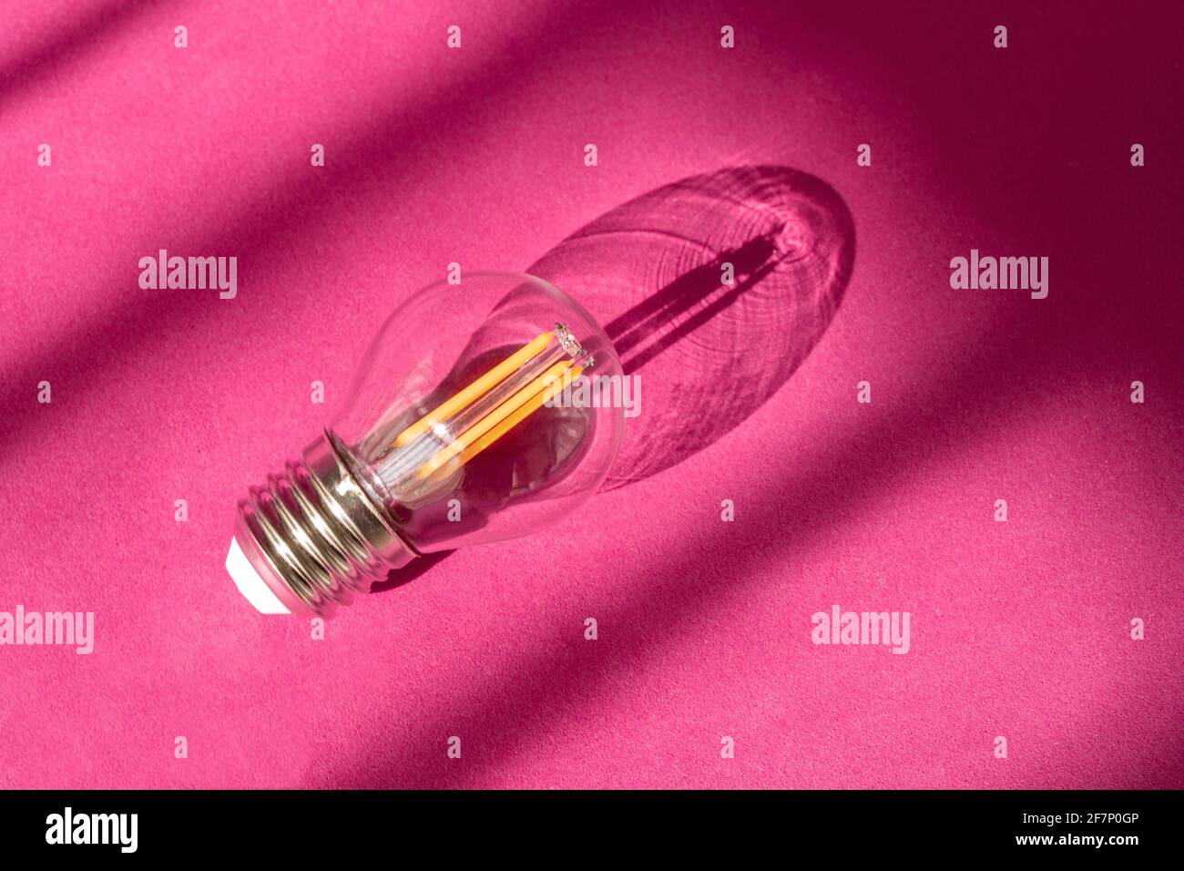 Light bulb on purple background with shadows close up. Lightbulb on ...