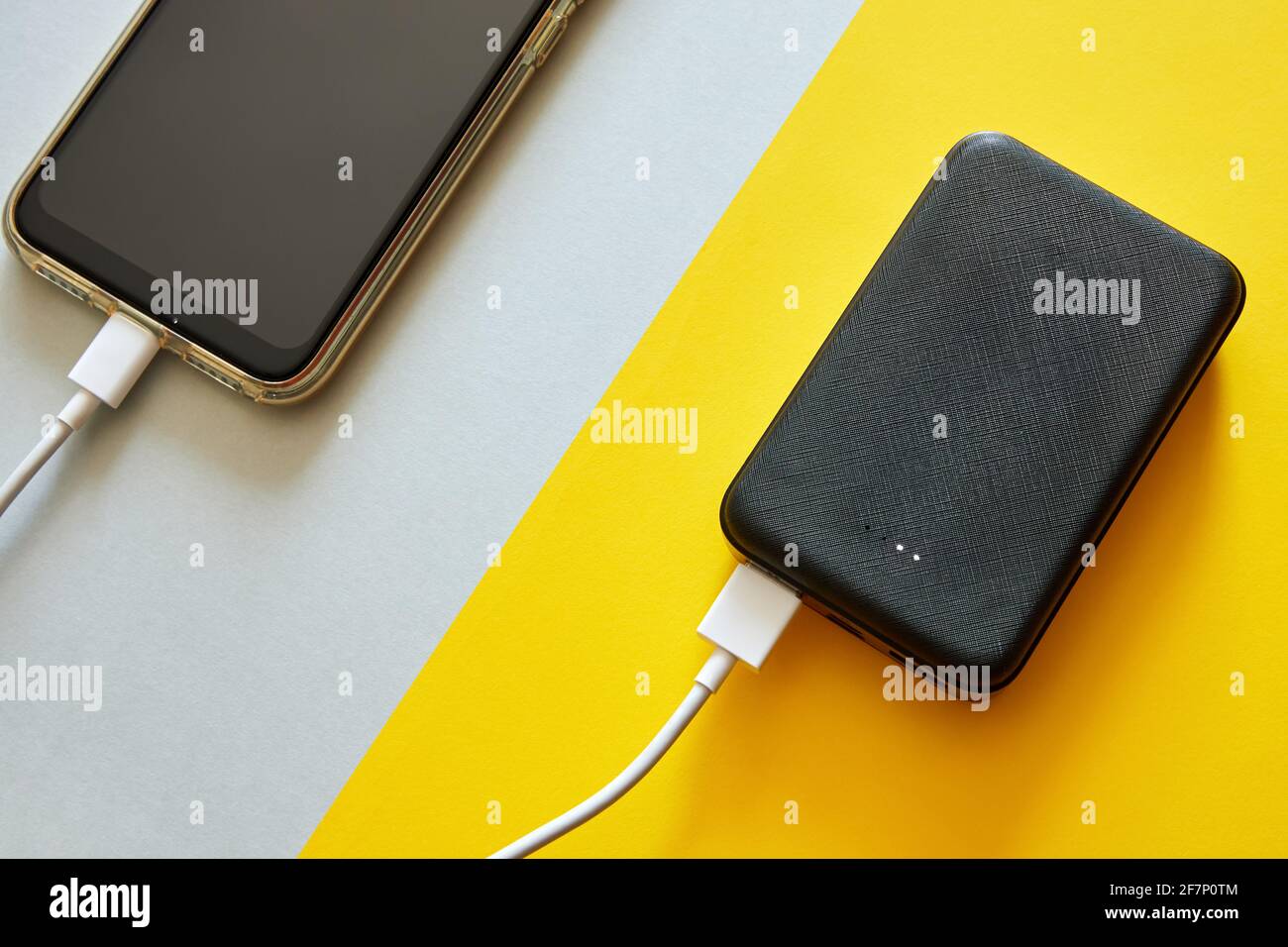 Power bank charges smartphone using a USB cable Stock Photo - Alamy