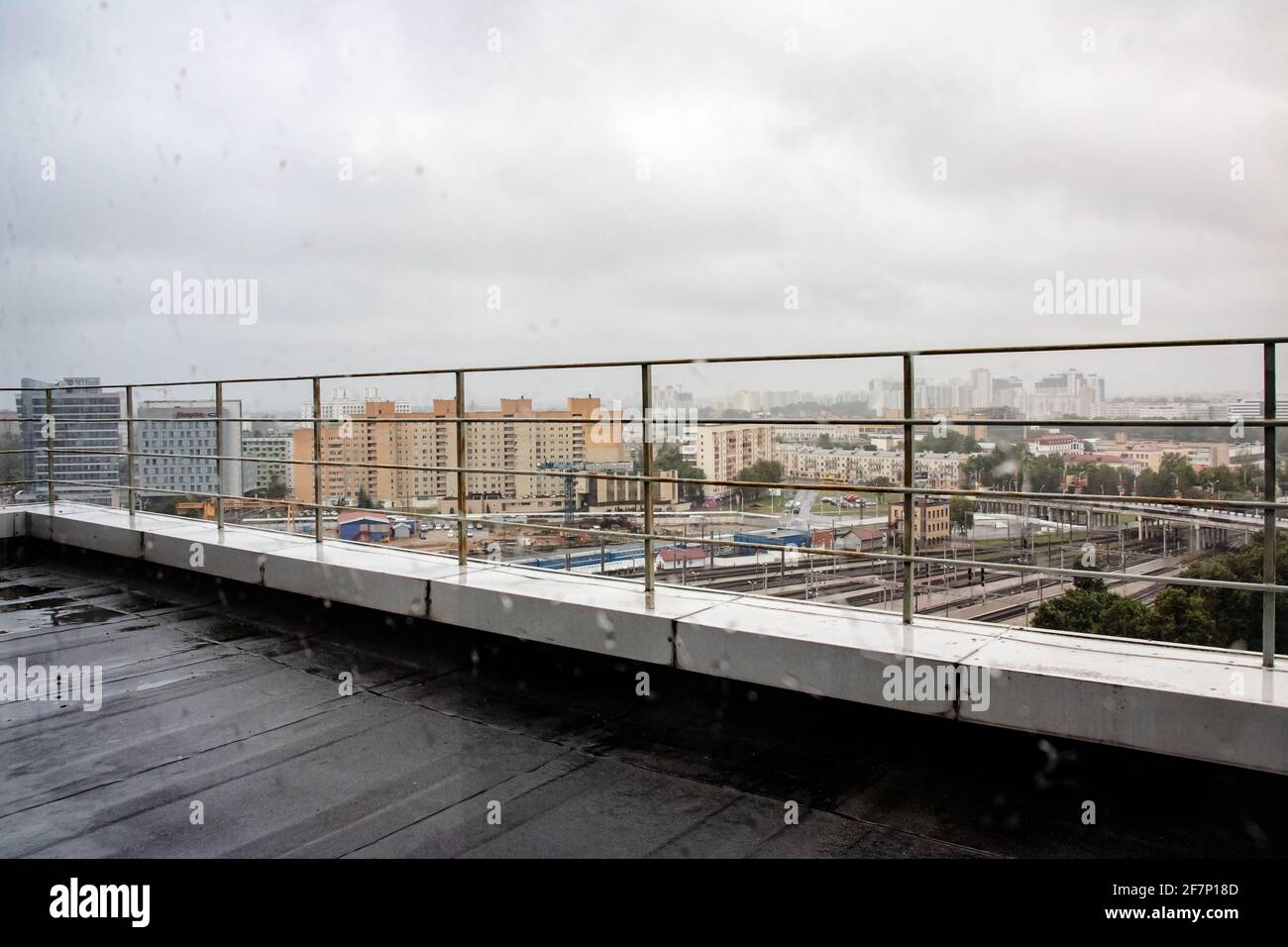 View of the rainy city and balcony railings Stock Photo - Alamy