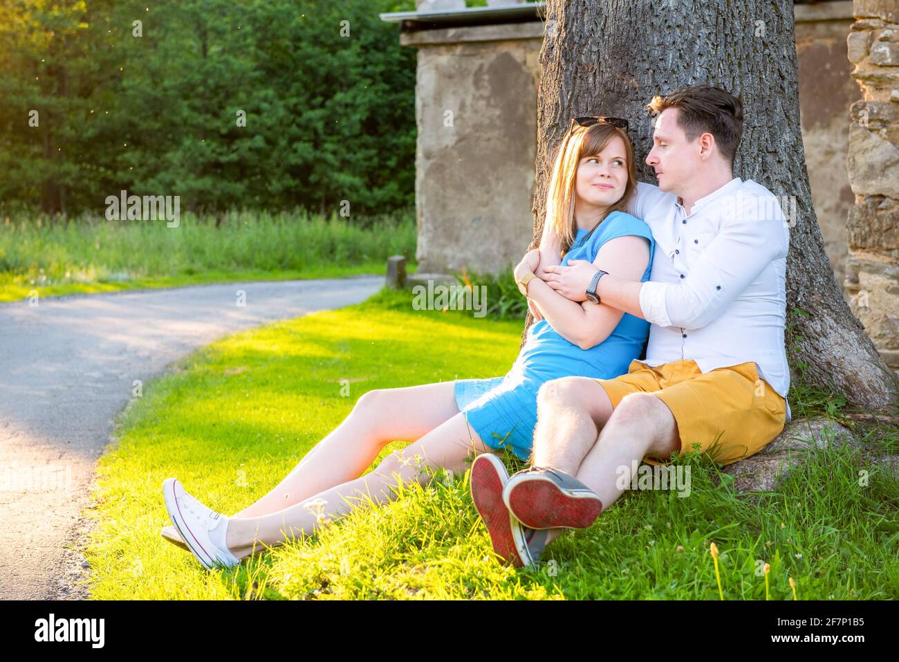 Happy and in love. Young Couple Embracing Under Tree. Couple in love ...