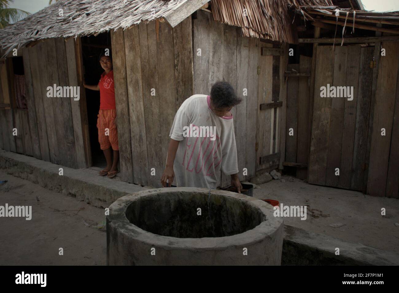 Women at a communal water well in Yembekwan, a coastal village in Raja ...
