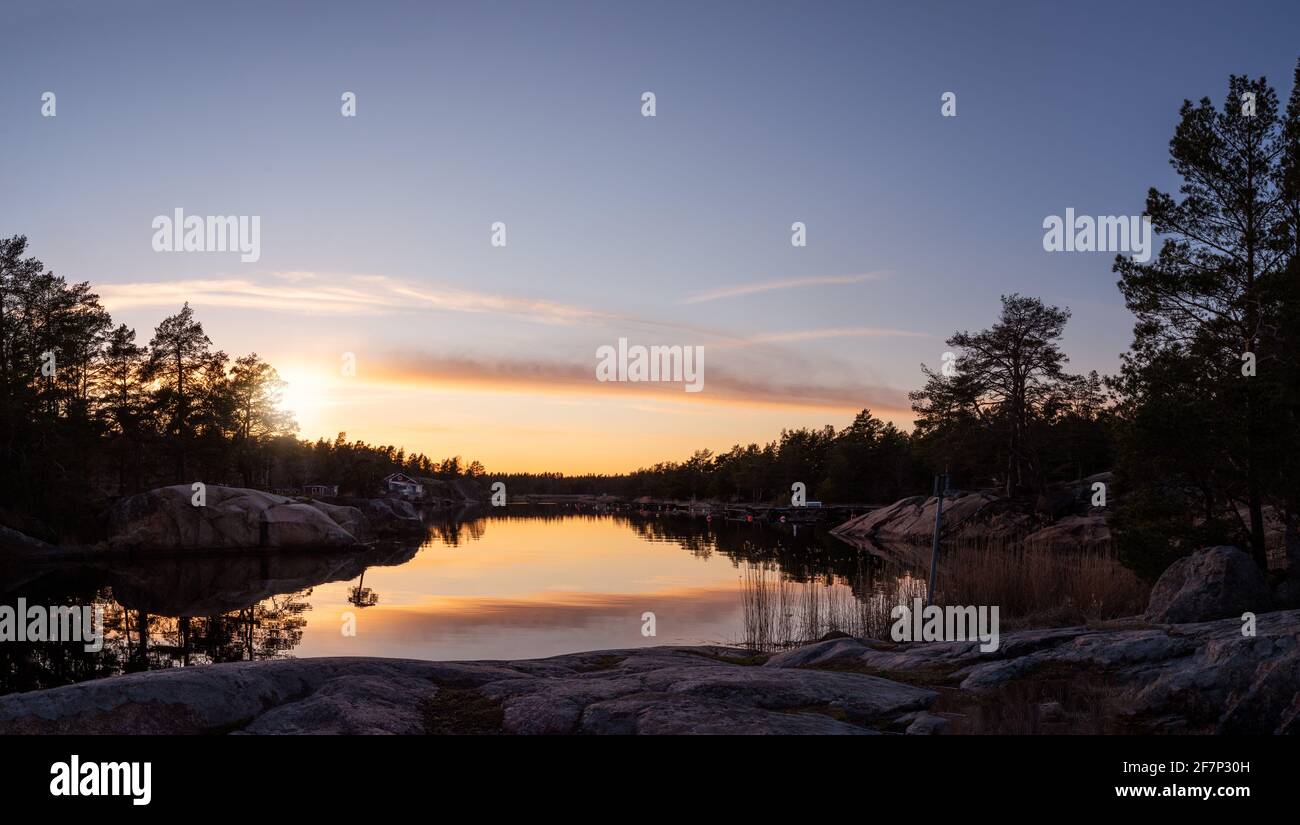 Panorama view of sunset in the Swedish archipelago. Rocks, calm water ...