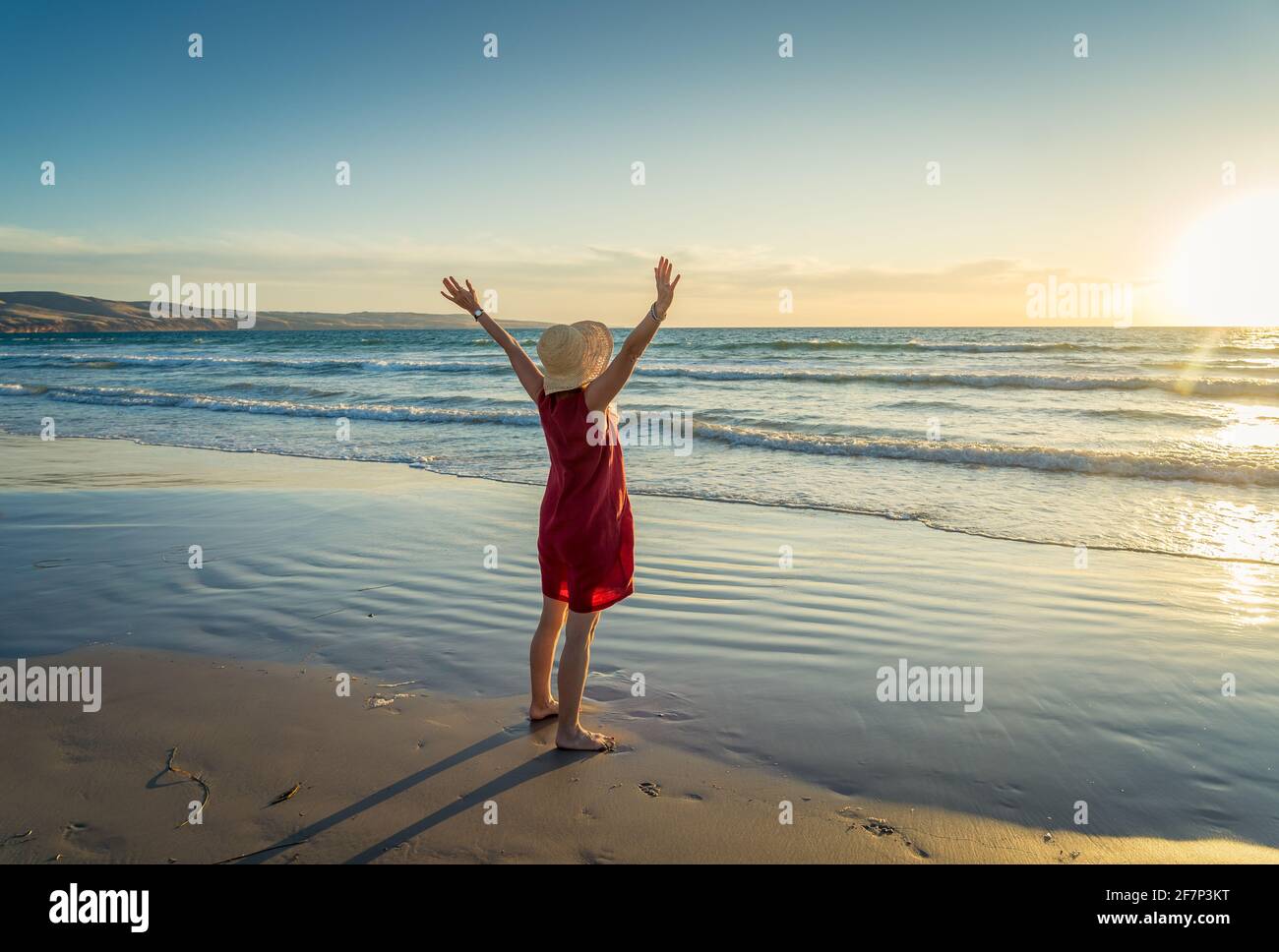 Happy attractive Mature woman in red dress enjoying outdoors and ...