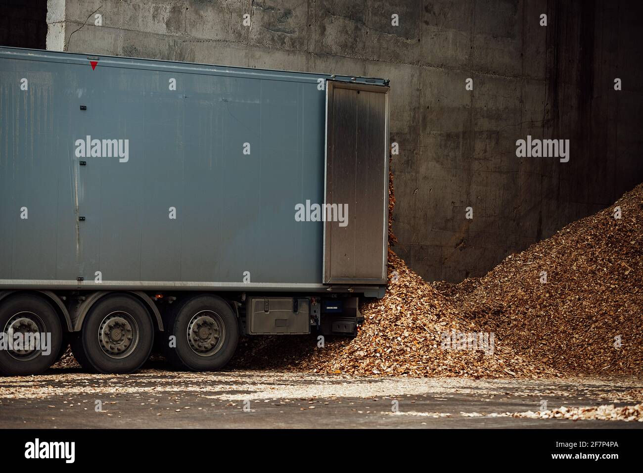 the truck unloads tons of wood waste. sawdust and shavings are stored ...