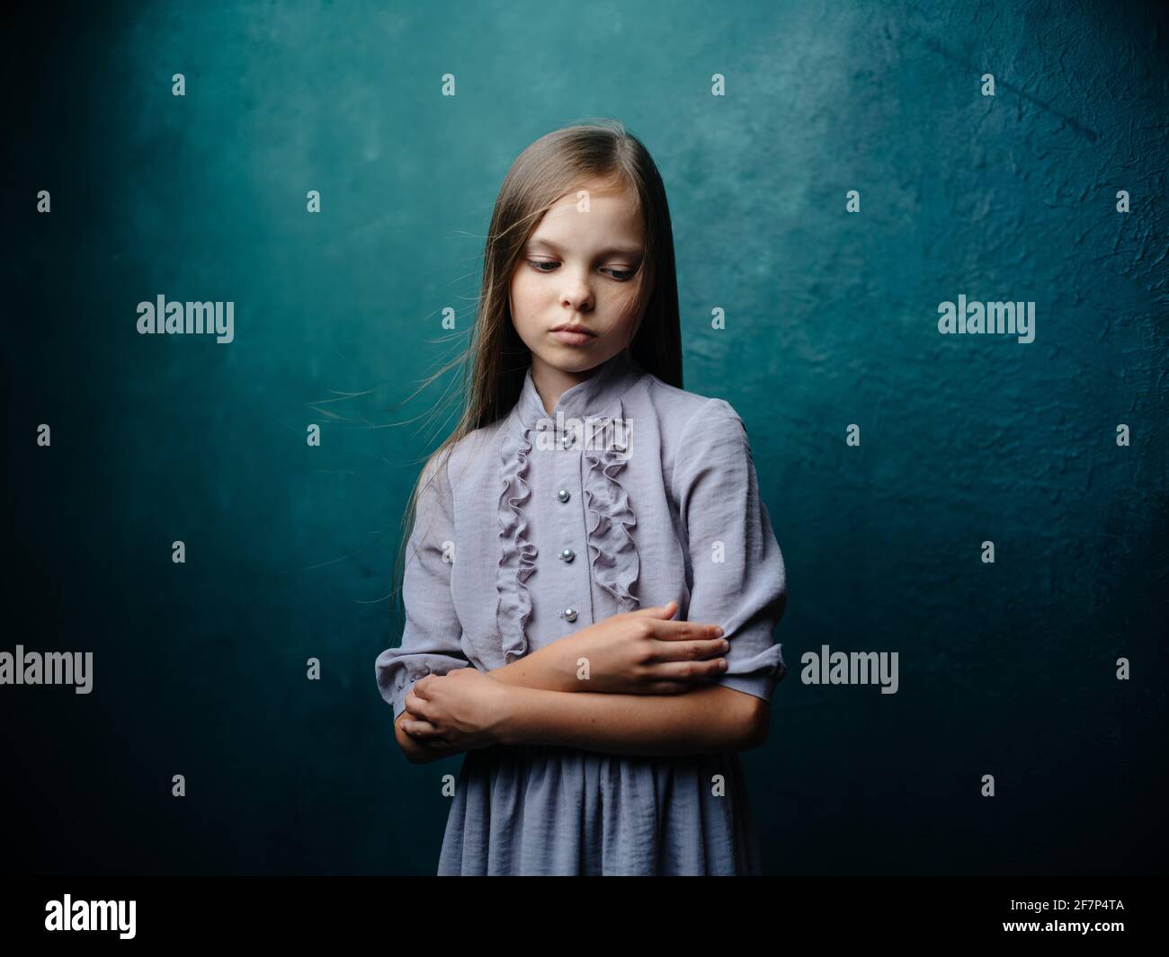 Pretty girl in a gray sundress with loose hair on a turquoise ...