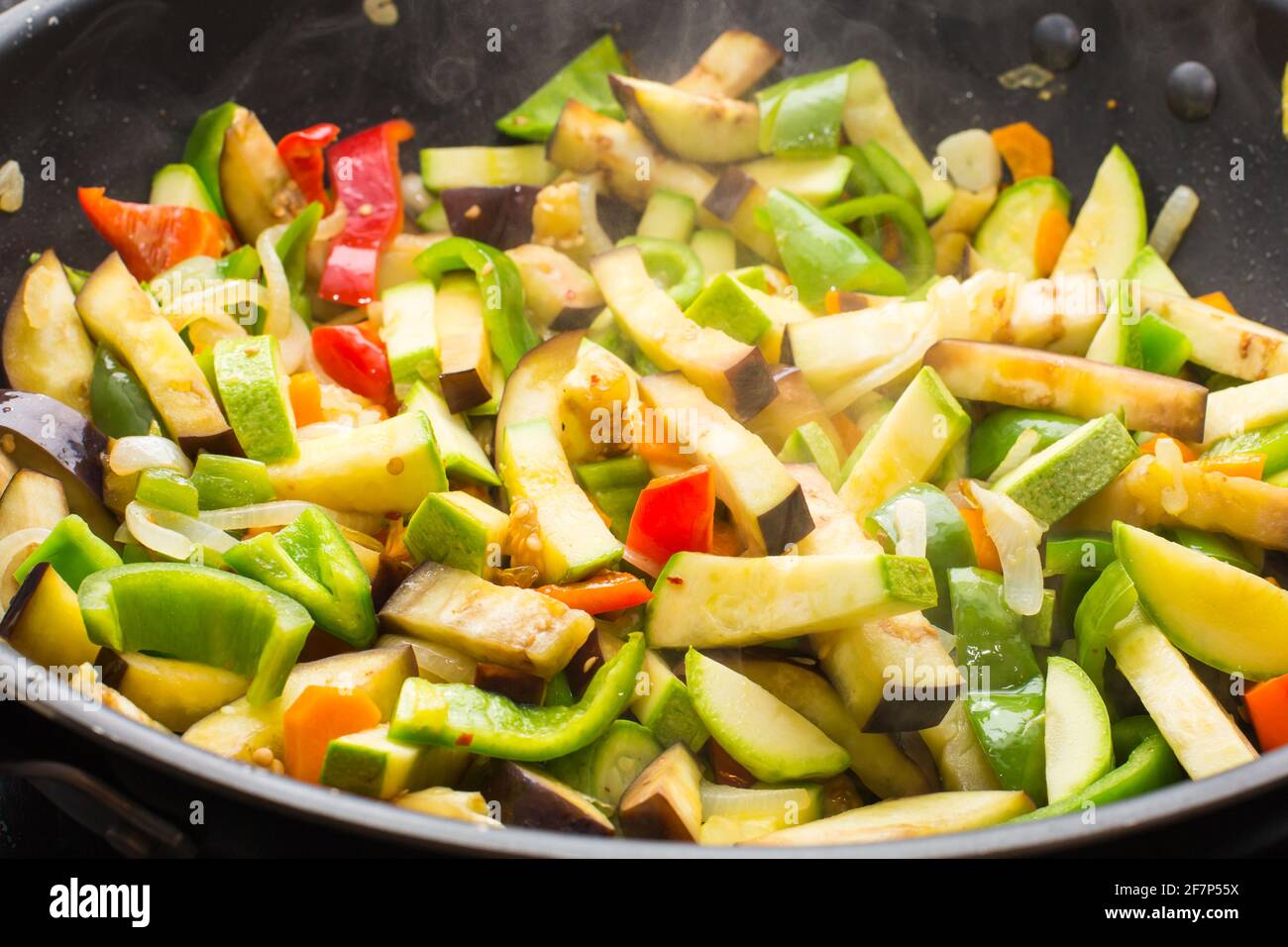 Cooking many different veggies pepper, onion, eggplant, summer squash ...