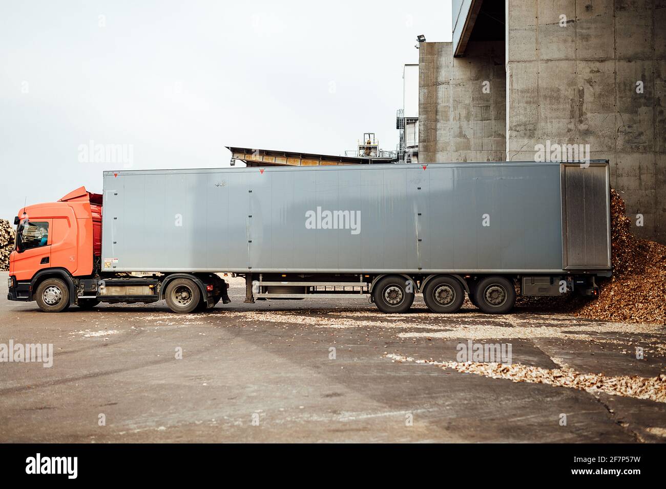 the truck unloads tons of wood waste. sawdust and shavings are stored ...