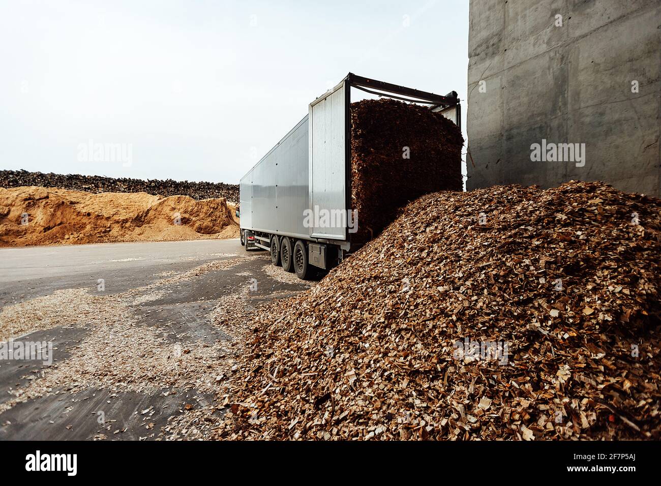 the truck unloads tons of wood waste. sawdust and shavings are stored ...