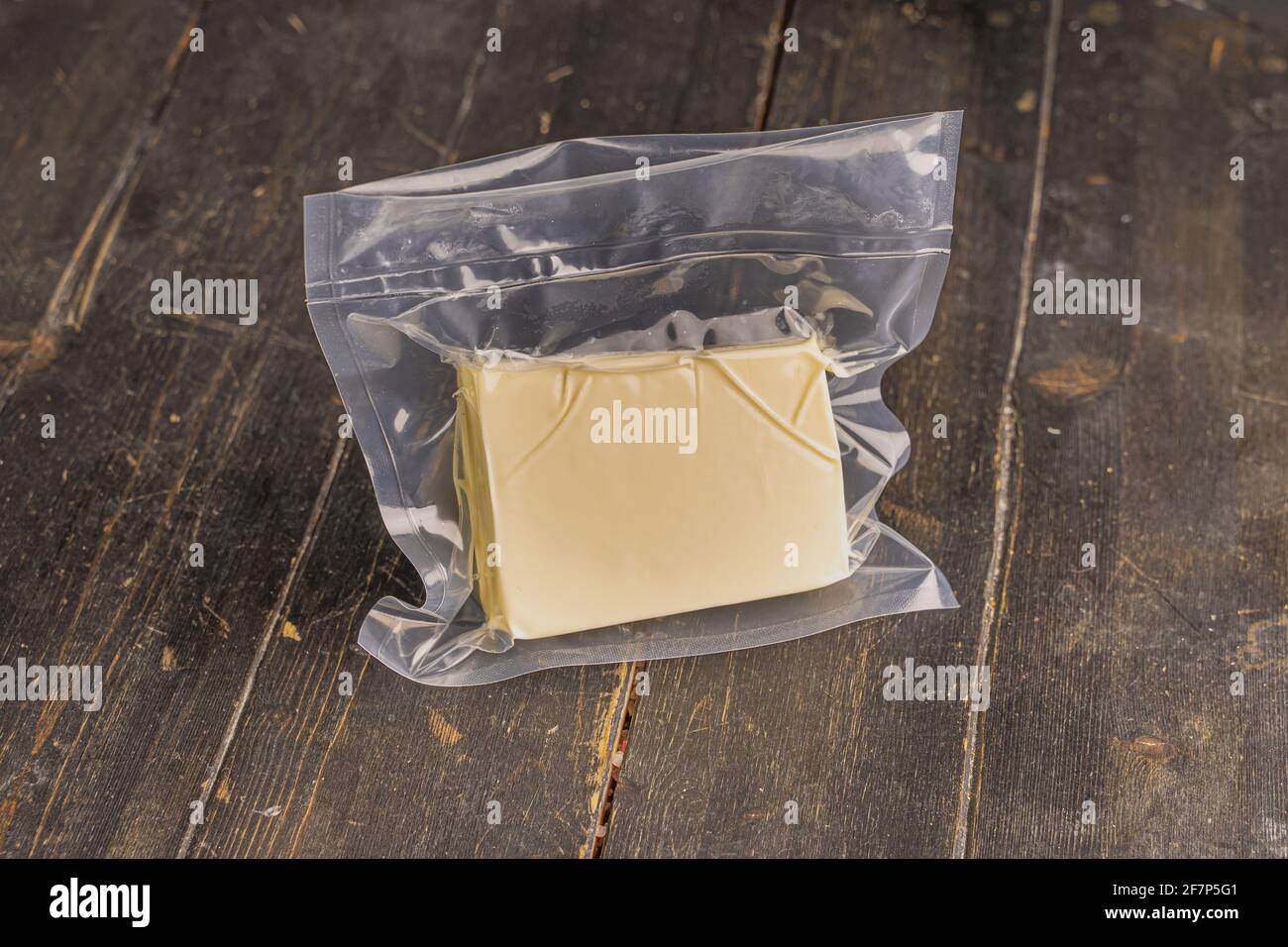 Fresh butter in a vacuum packet on wooden background Stock Photo - Alamy