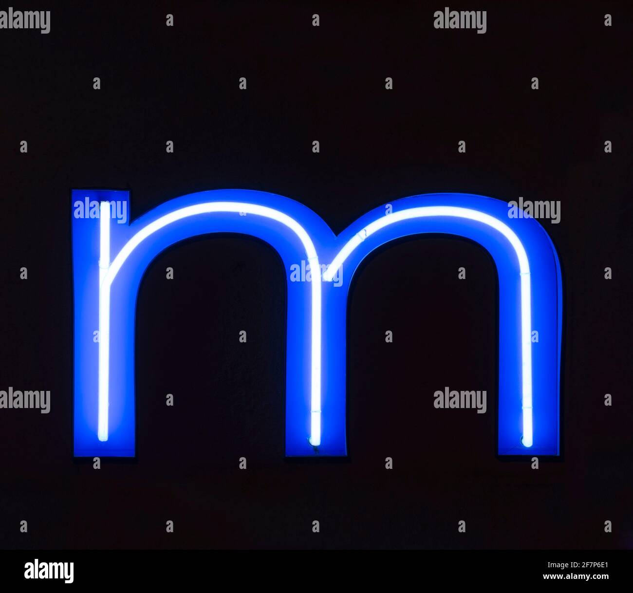 Blue shining neon letter m at night Stock Photo - Alamy