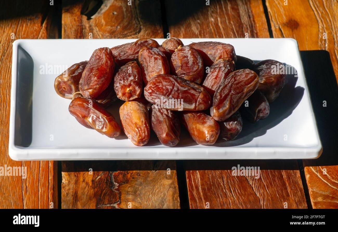 Sweet Khalas dates fruit from Saudi Arabia in the white plate ready for ...