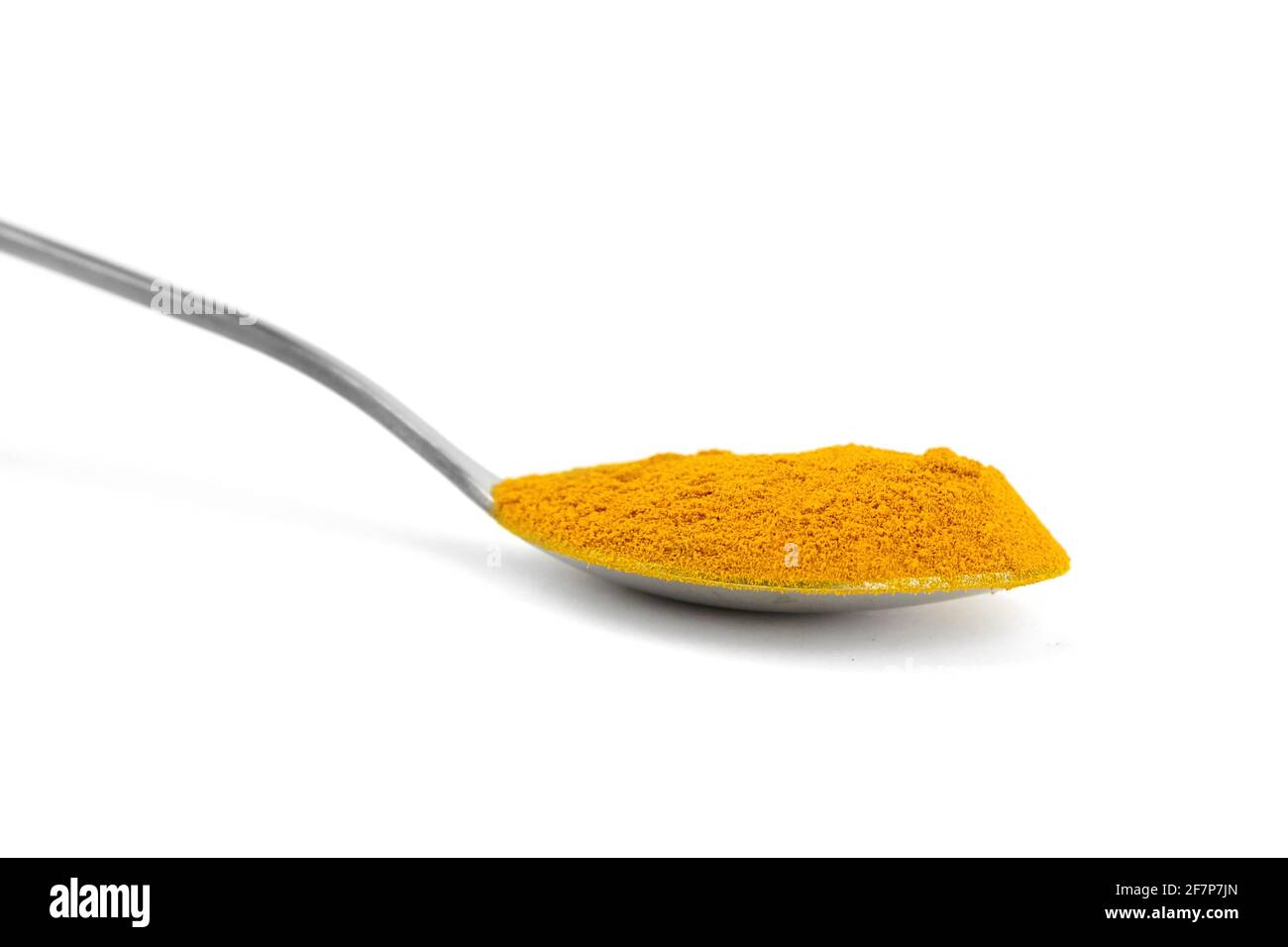 Curcuma powder in spoon isolated on white background. Turmeric powder ...