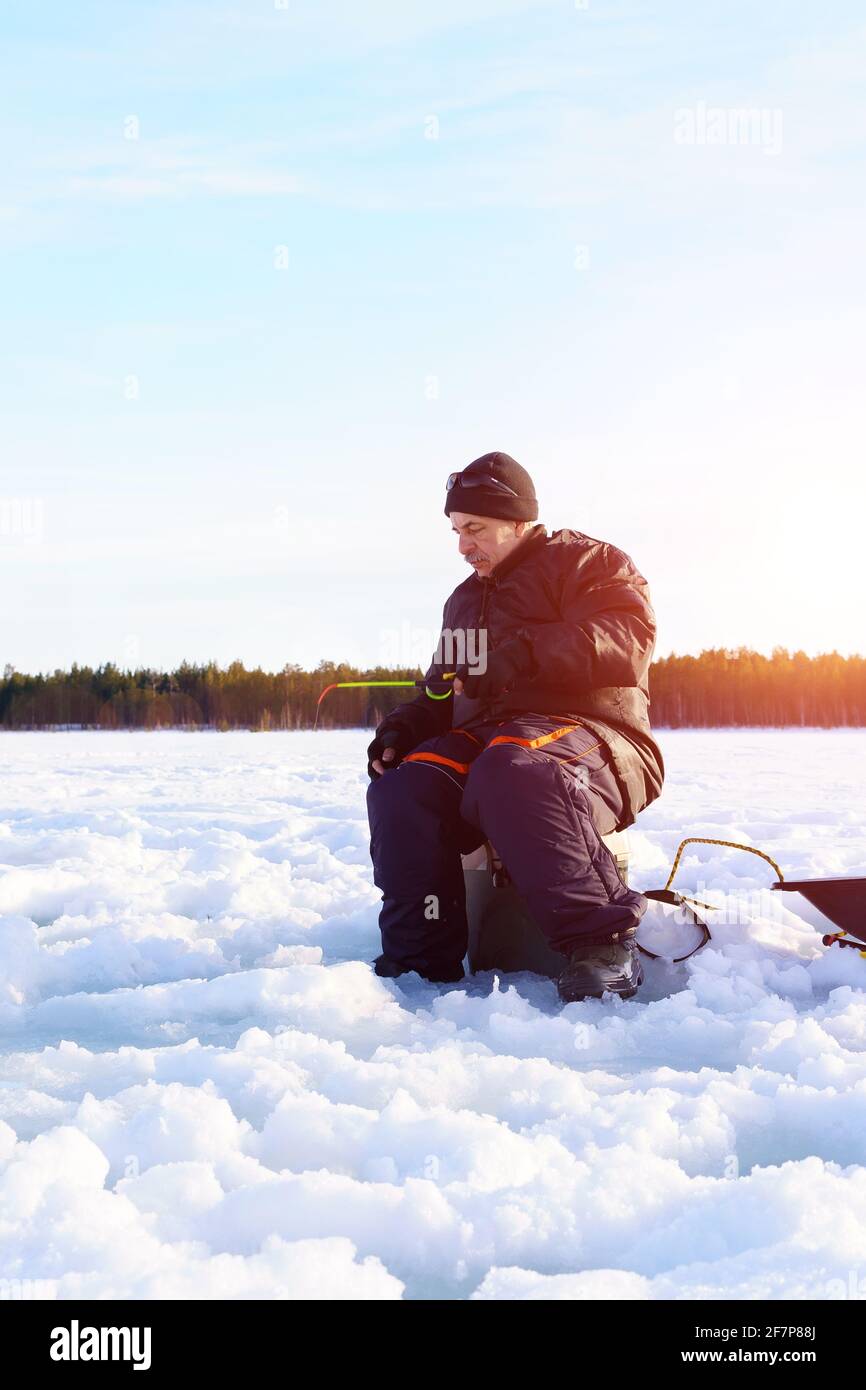 ice fishing. fisherman fishing on frozen lake. Winter frosty morning ...