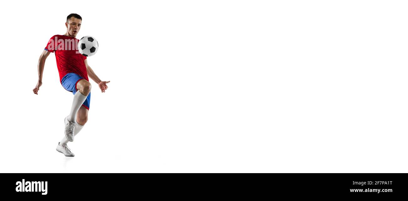 Porttrait of young soccer football player training isolated on white ...