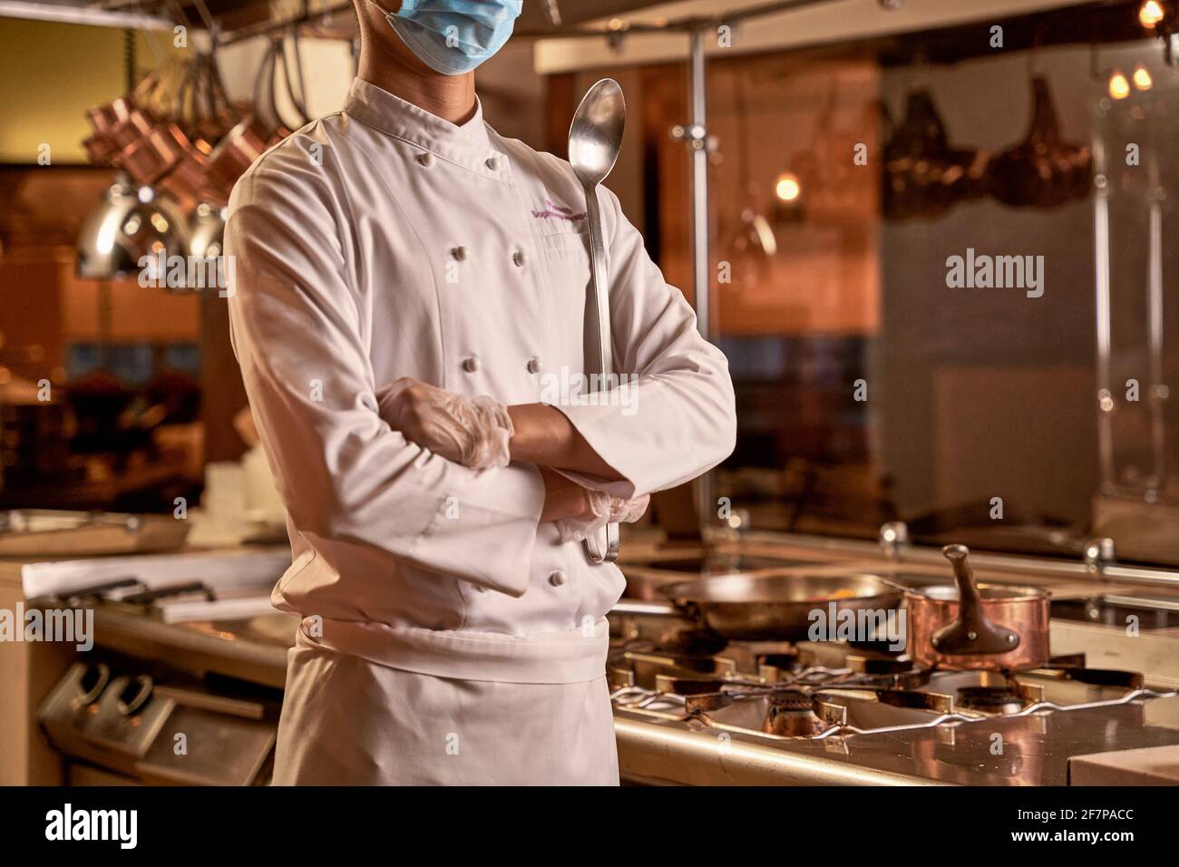 Proud chef standing with crossed arms in kitchen Stock Photo - Alamy