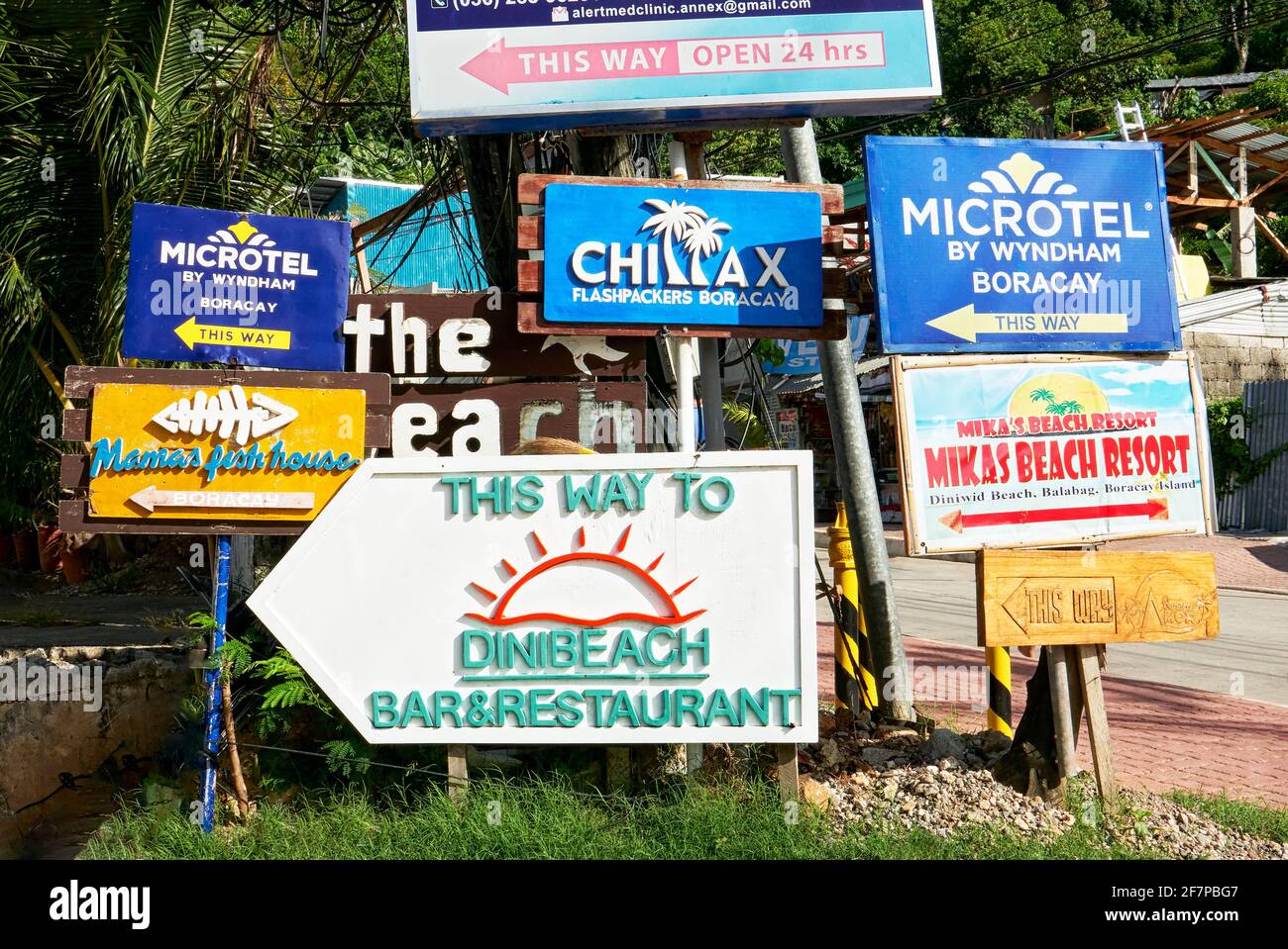 Close-up of many colorful road signs showing the way to hotel ...