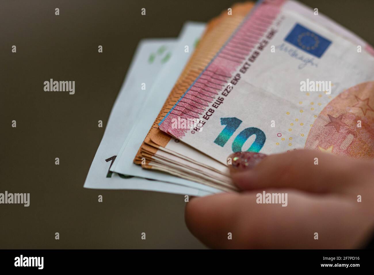 Selective focus on detail of EURO banknotes. Counting or giving EURO ...