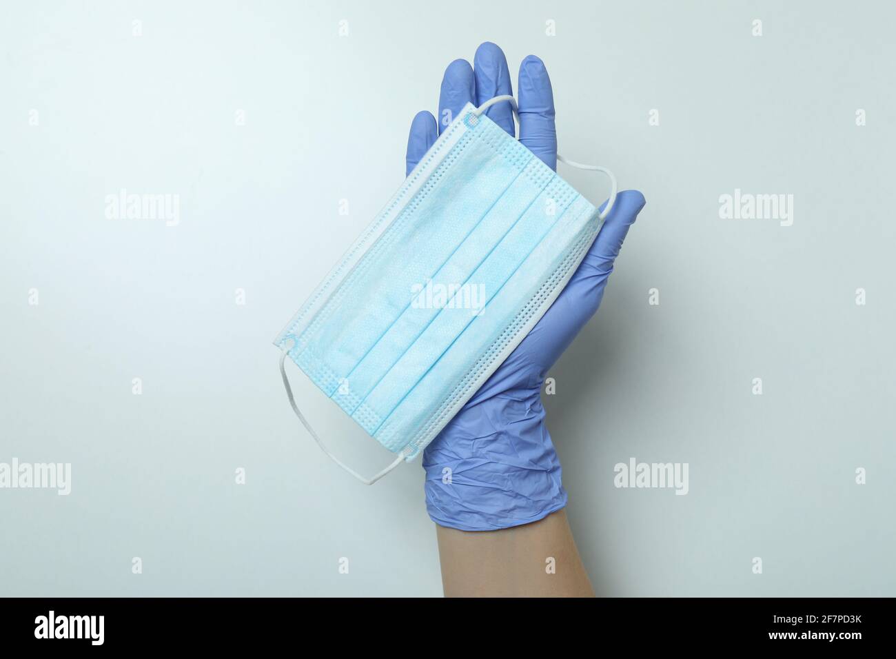 Hand in medical glove hold mask on white background Stock Photo - Alamy