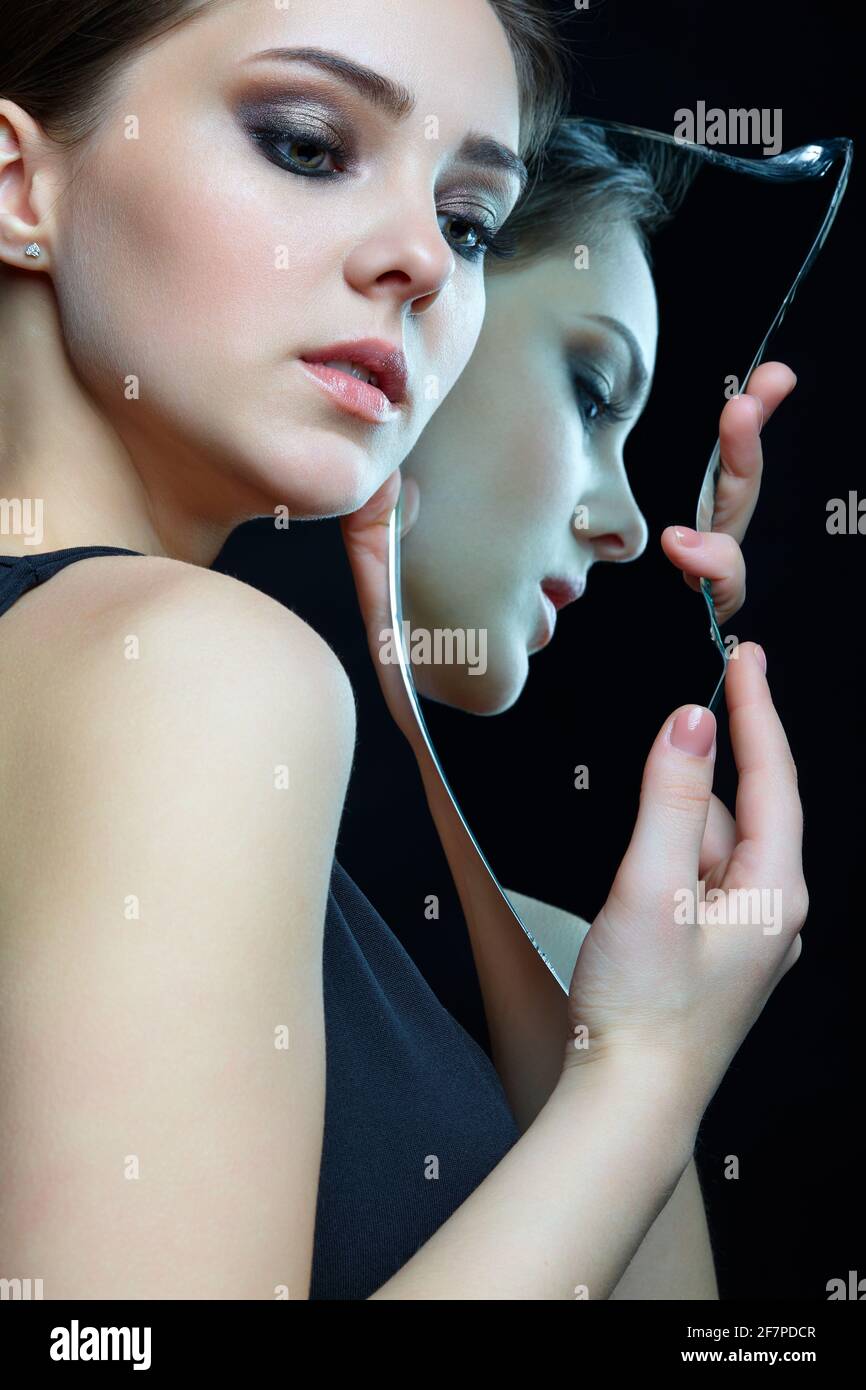 Girl with a shard of the mirror. Female with mirror shard in hand ...