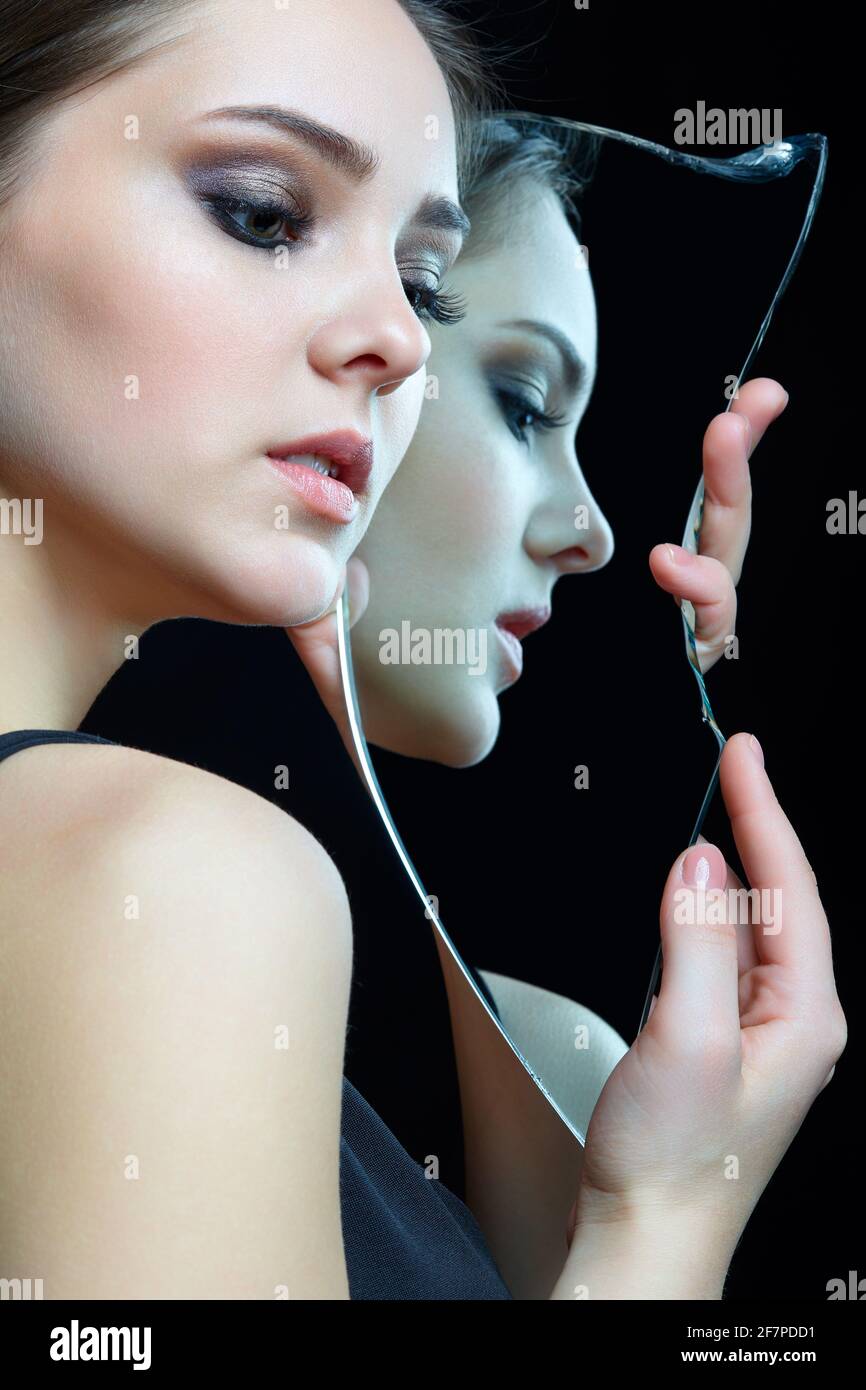 Girl with a shard of the mirror. Female with mirror shard in hand ...