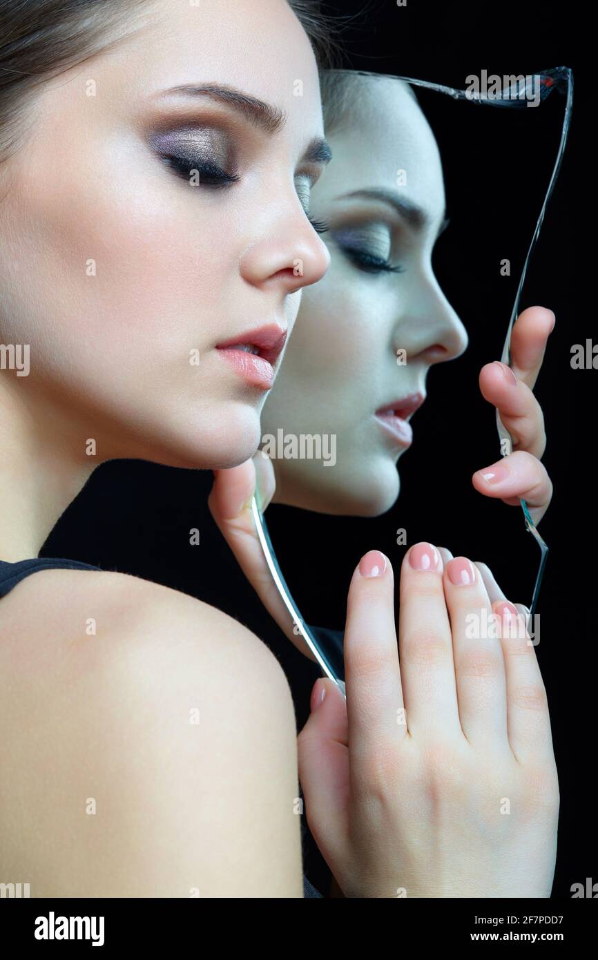 Girl with a shard of the mirror. Female with mirror shard in hand ...