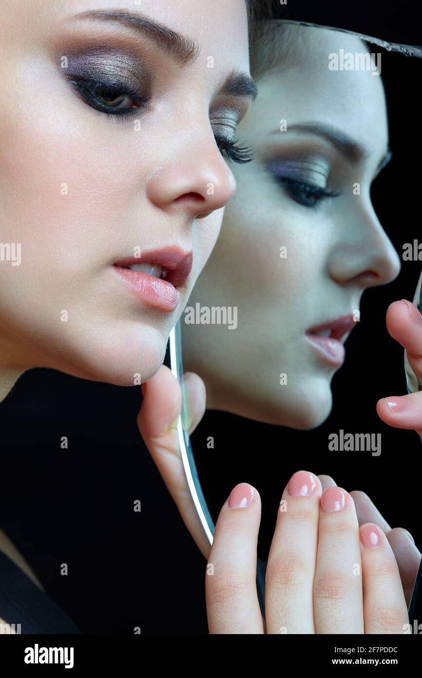 Girl with a shard of the mirror. Female with mirror shard in hand ...