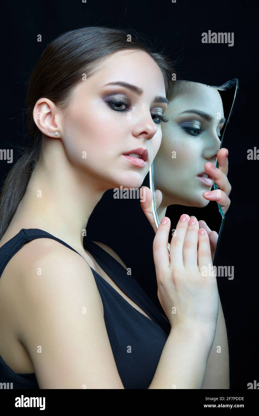 Girl with a shard of the mirror. Female with mirror shard in hand ...