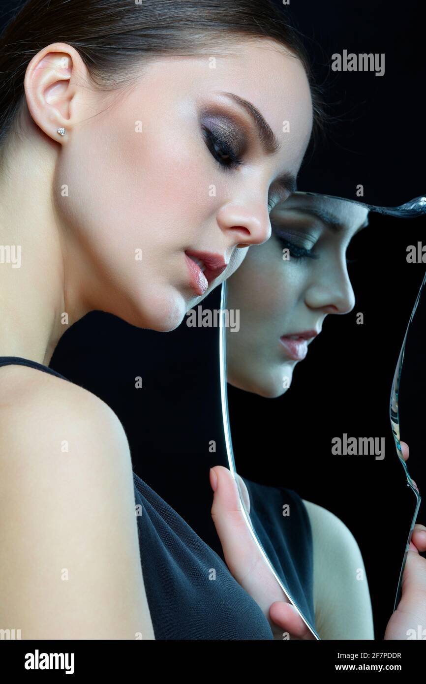 Girl with a shard of the mirror. Female with mirror shard in hand ...