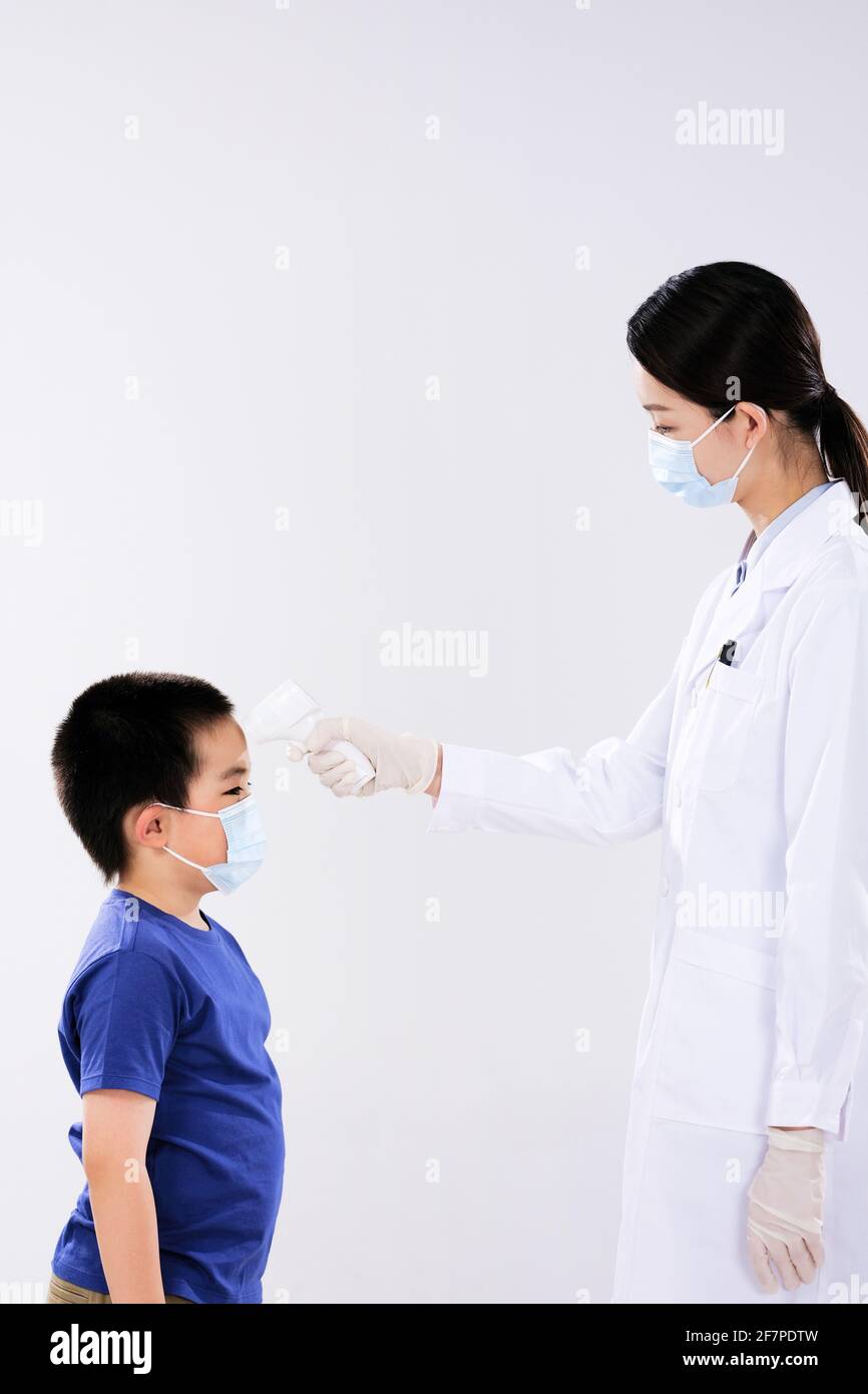 A woman doctor took the little boy's temperature face to face Stock ...