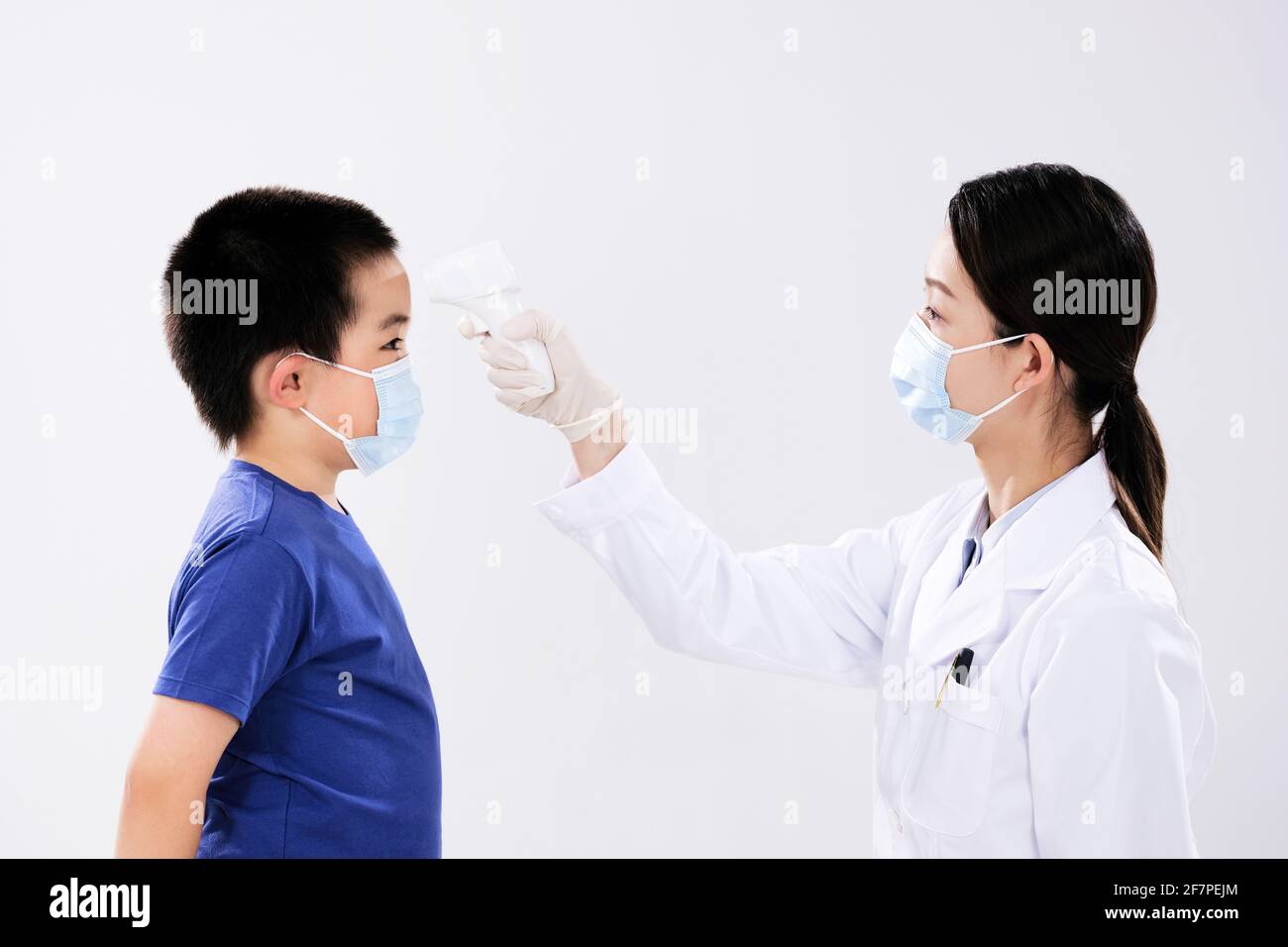 A woman doctor took the little boy's temperature face to face Stock ...