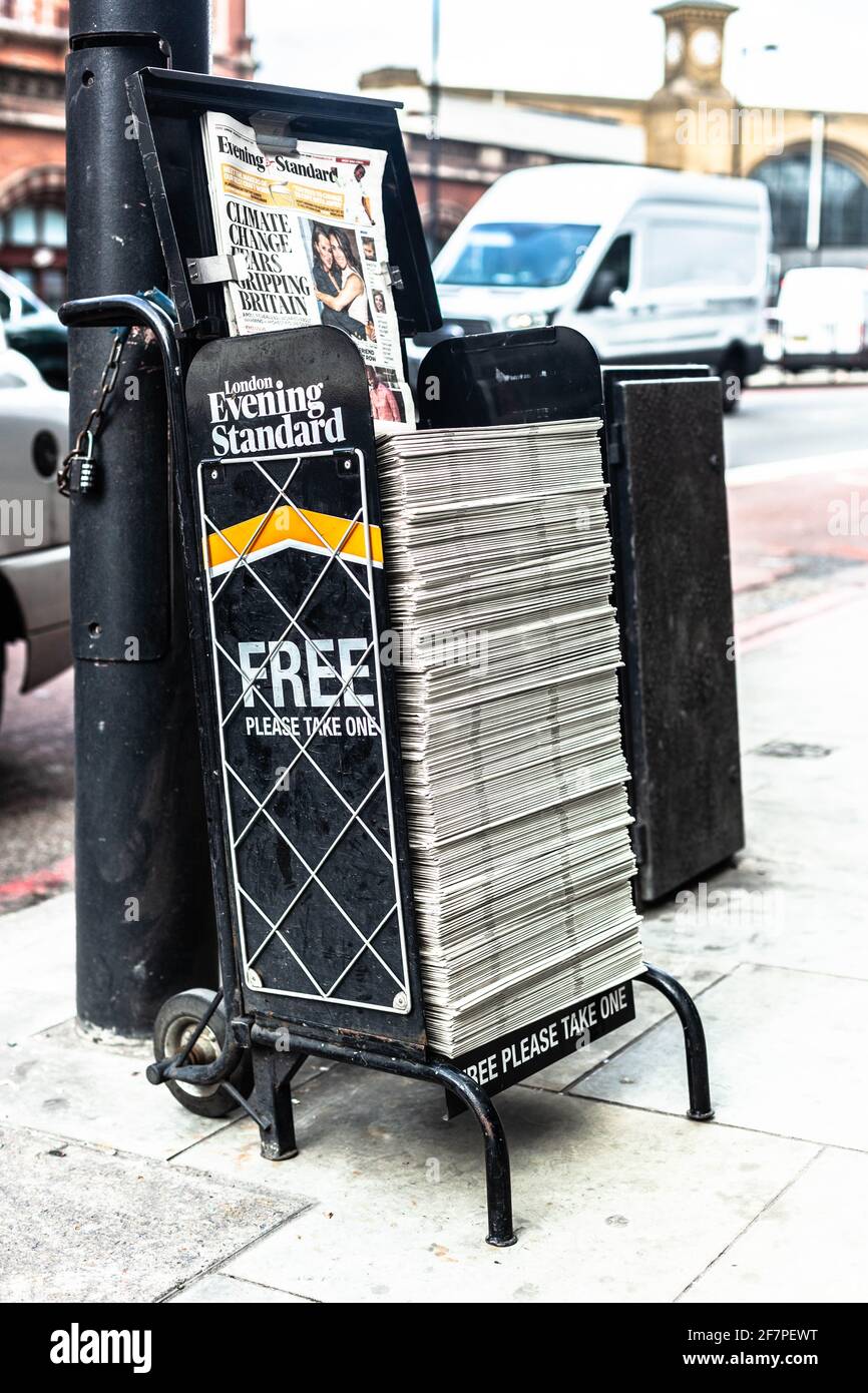 An Evening Standard free newspaper stand chained to a pavement post ...