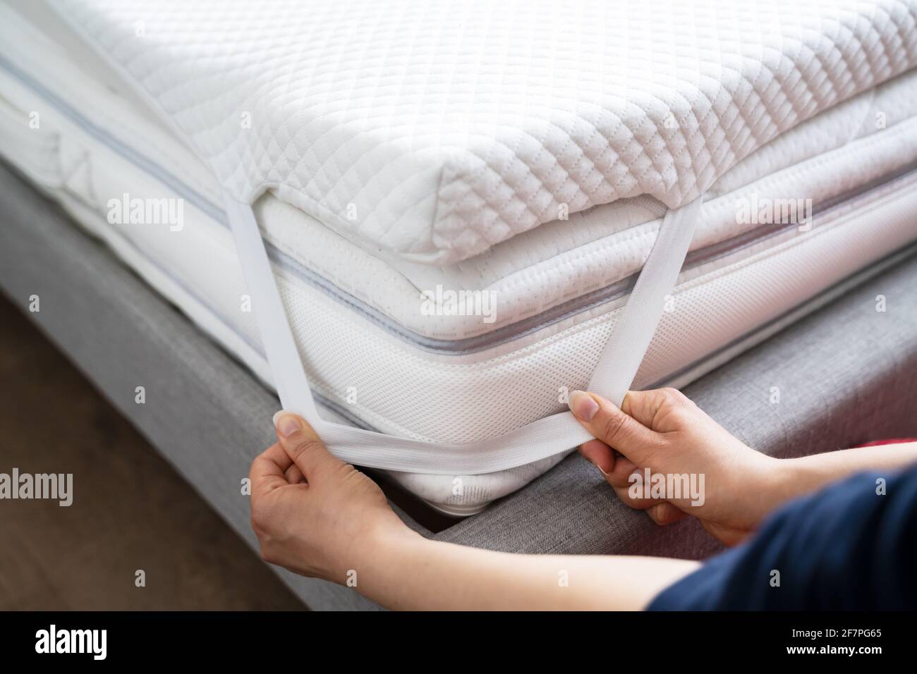 Mattress Topper Being Laid On Top Of The Bed Stock Photo - Alamy
