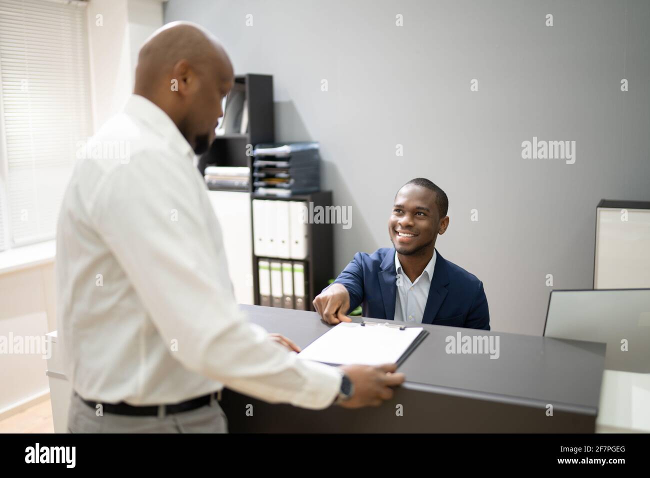 Young client at hotel reception hi-res stock photography and images - Alamy