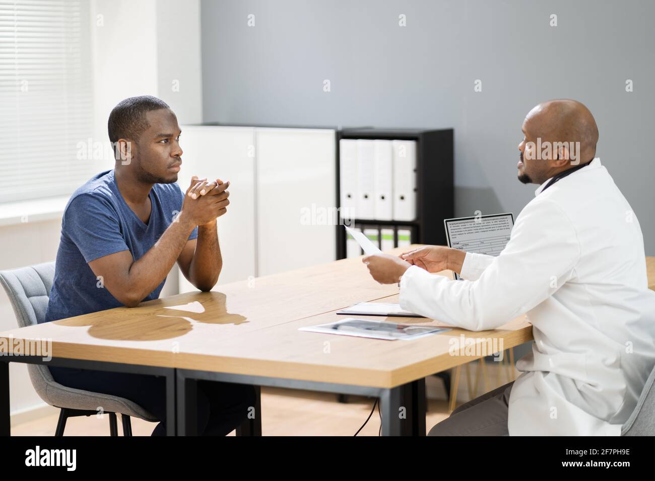 Professional afro american doctor holding hi-res stock photography and ...