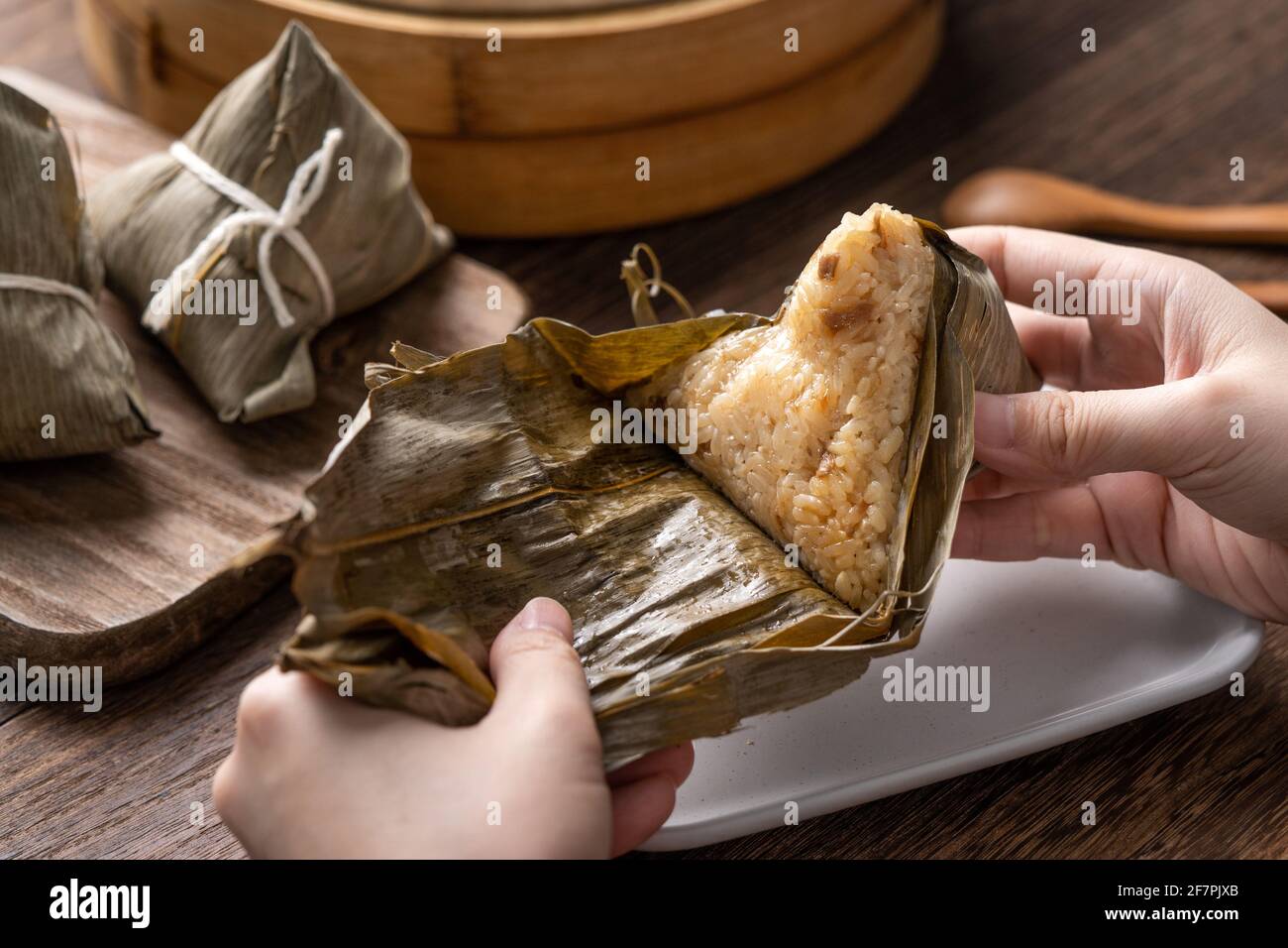 Eating Zongzi rice dumpling for Chinese traditional Dragon Boat ...
