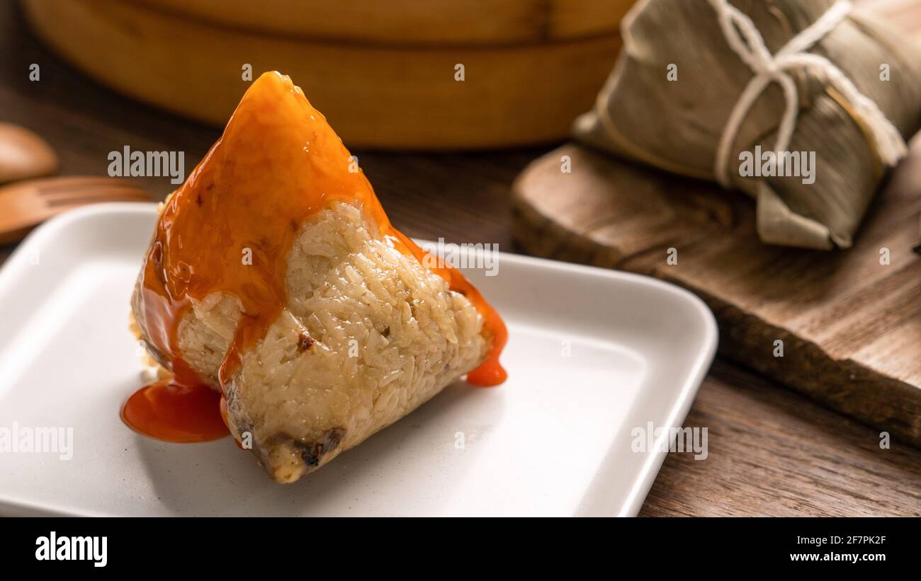 Eating Zongzi rice dumpling for Chinese traditional Dragon Boat ...