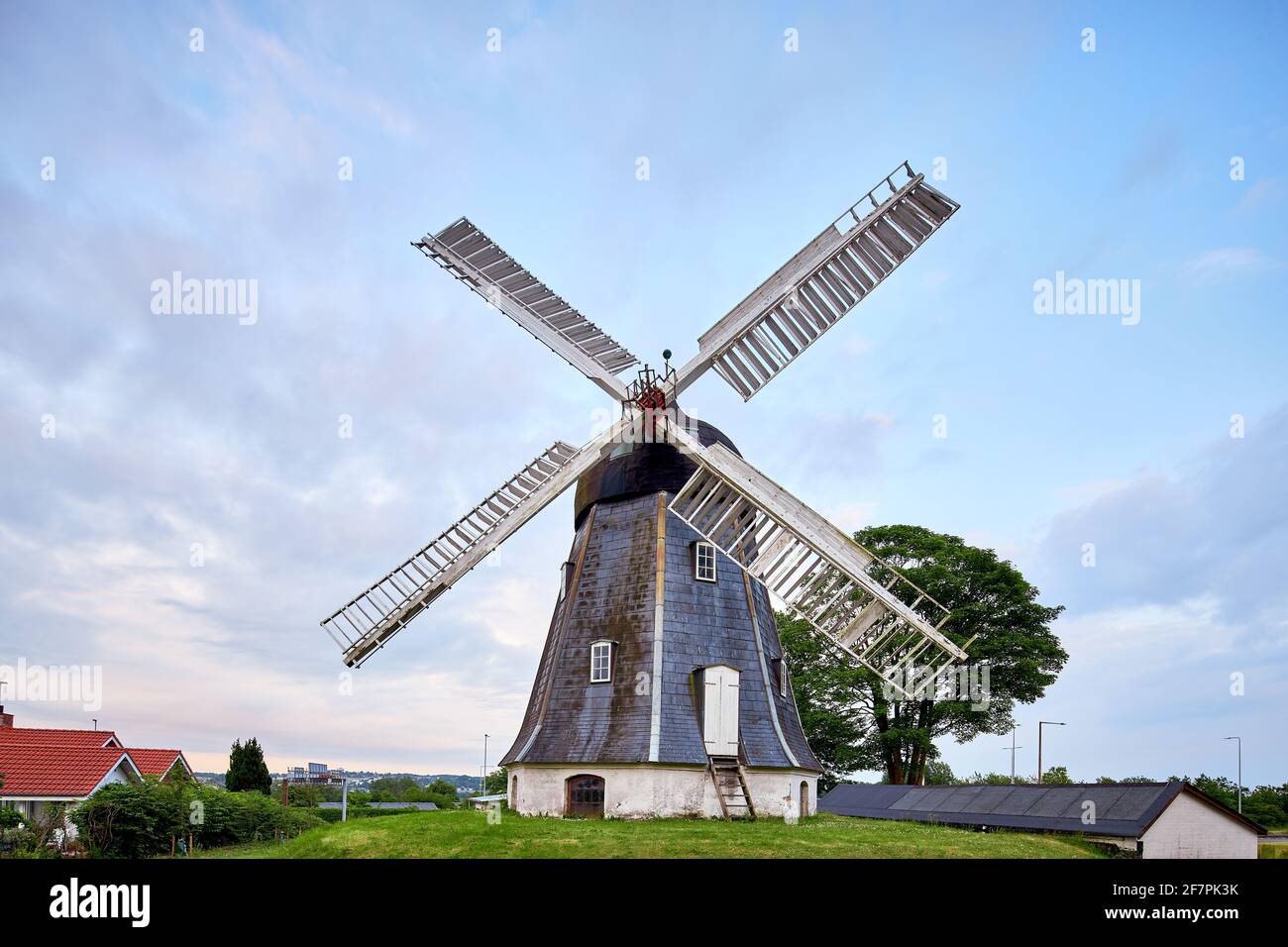 old and antique windmill next to house in denmark Stock Photo - Alamy