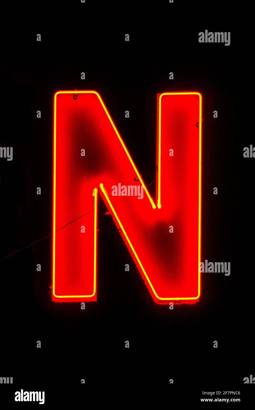 Red glowing neon letter N at night Stock Photo - Alamy