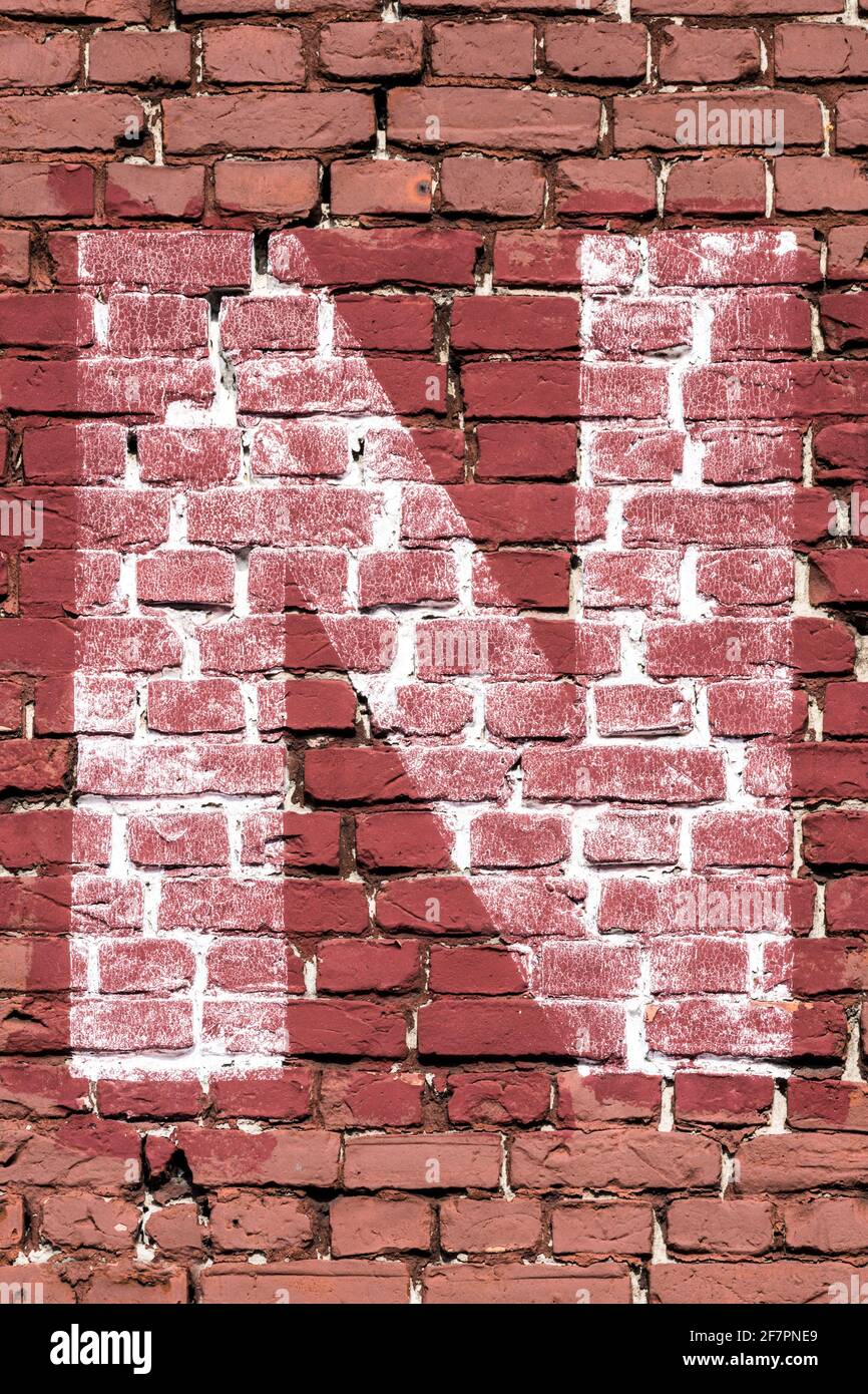 The letter N painted white on a red brick wall Stock Photo - Alamy