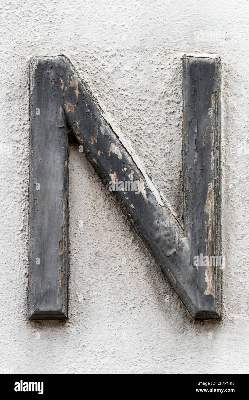 Wooden letter N with peeling black paint Stock Photo - Alamy