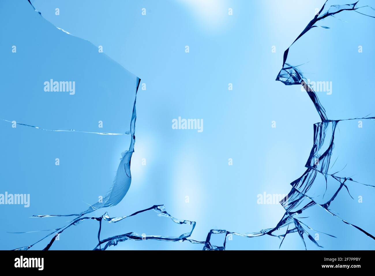 Broken window glass on a background of blue sky Stock Photo - Alamy