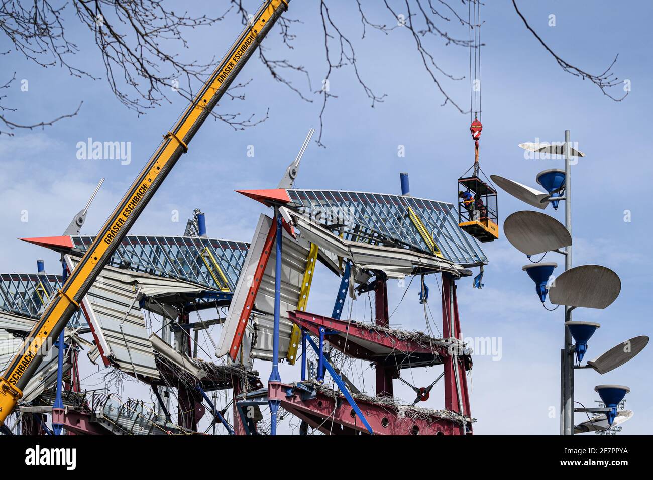 Two construction workers are working in a construction cage at a dizzy ...