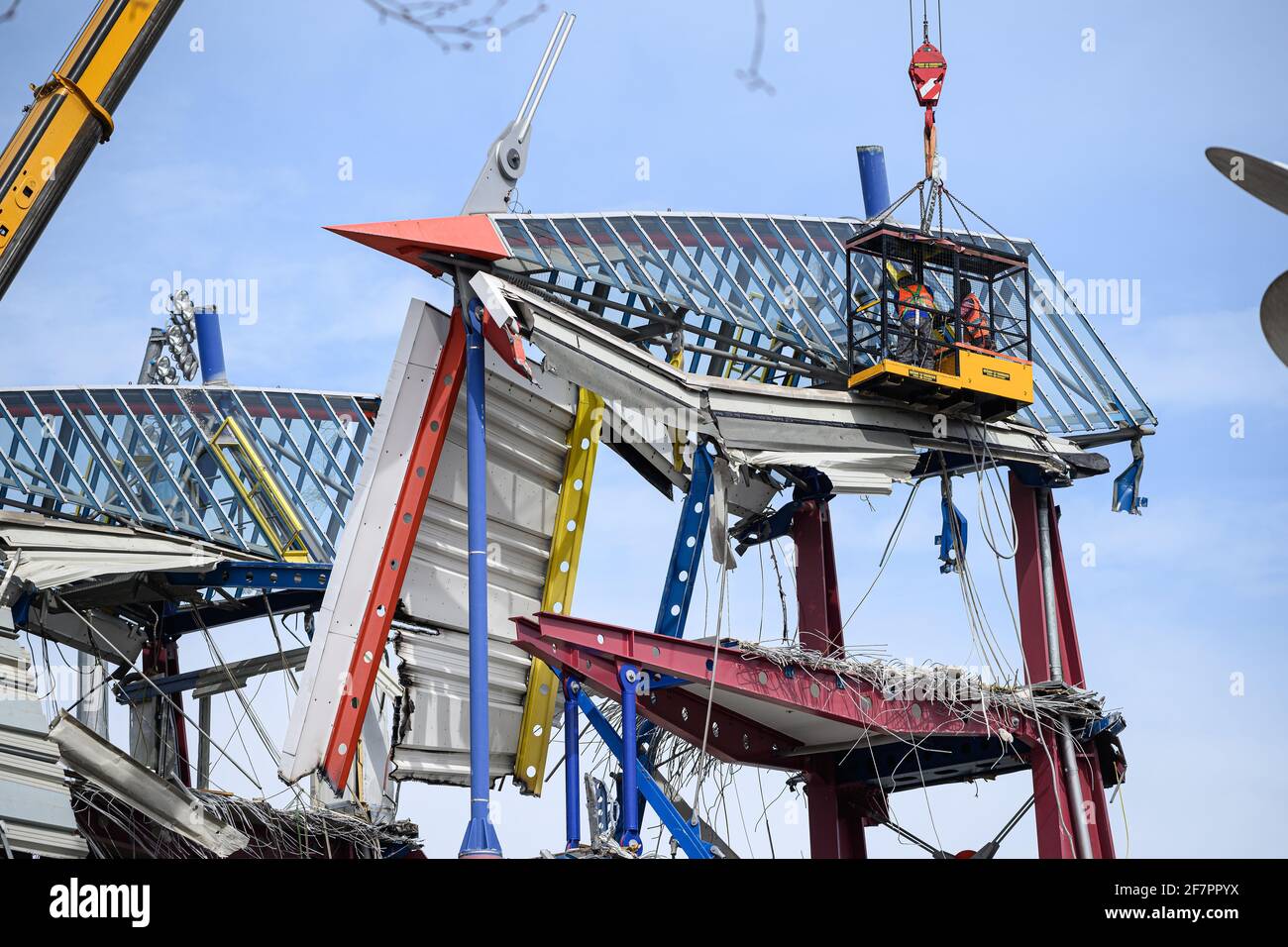 Two construction workers are working in a construction cage at a dizzy ...
