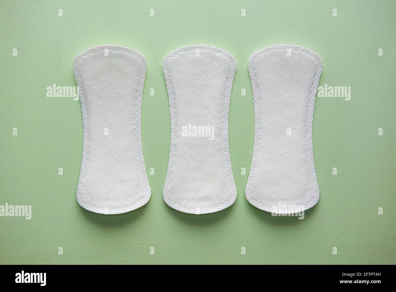 Three pads for women on a blue background Stock Photo - Alamy