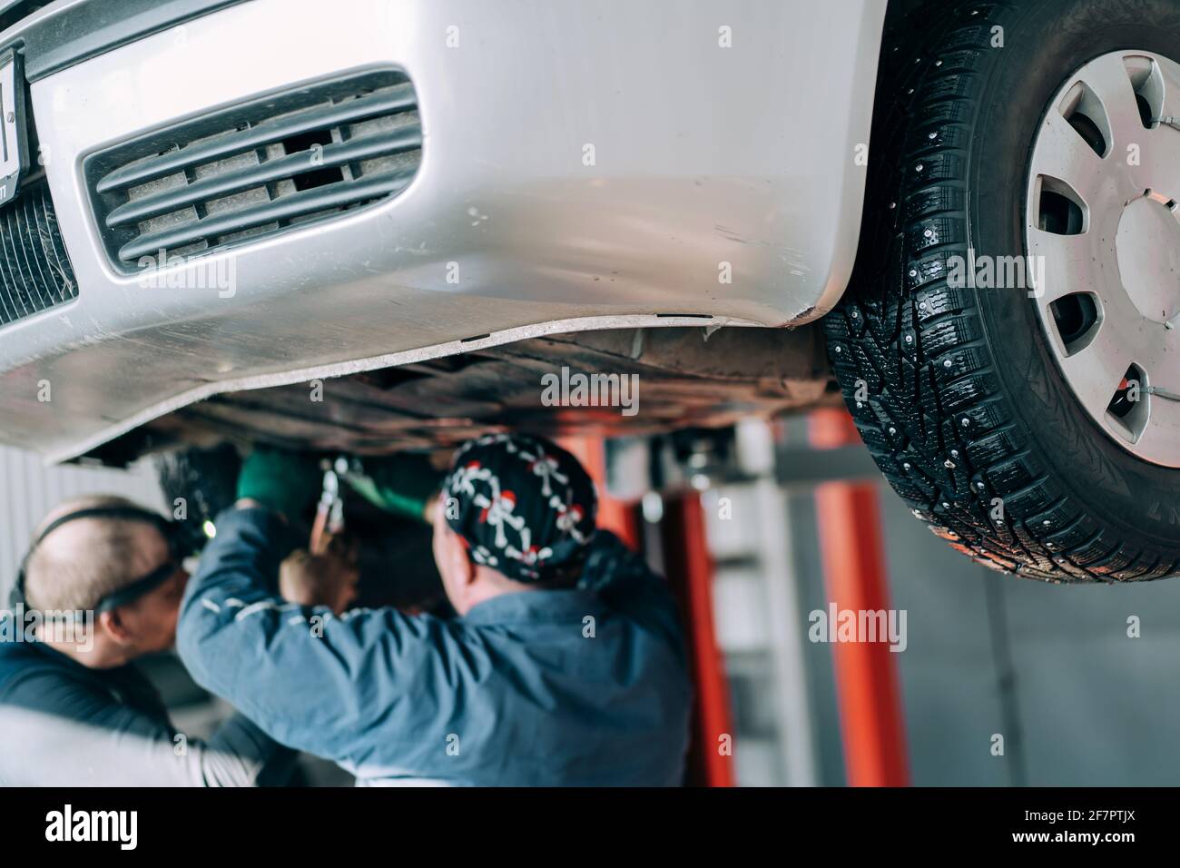 Professional mechanic repairs an internal combustion engine and changes ...