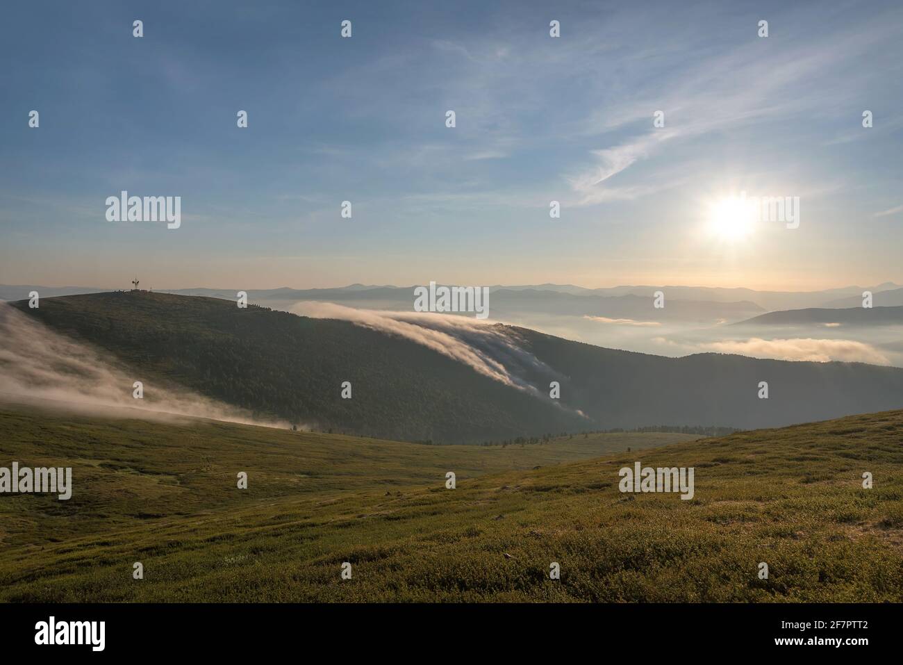 Amazing sunrise with beautiful fluffy fog, telecommunication tower at ...