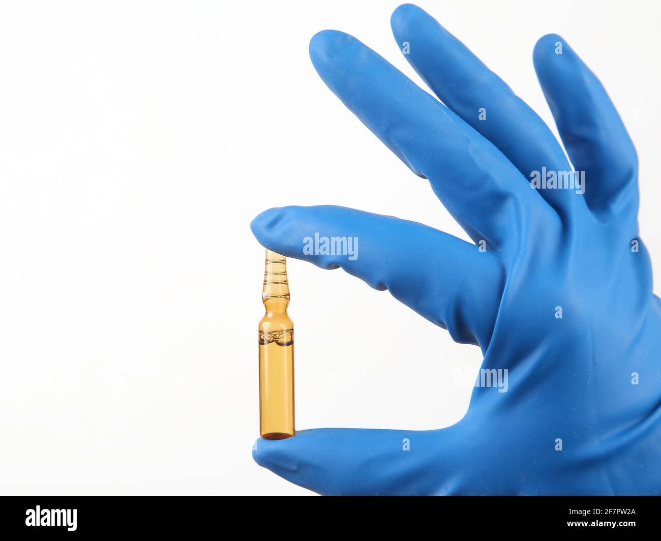 medical injection ampule in blue gloved hand Stock Photo - Alamy