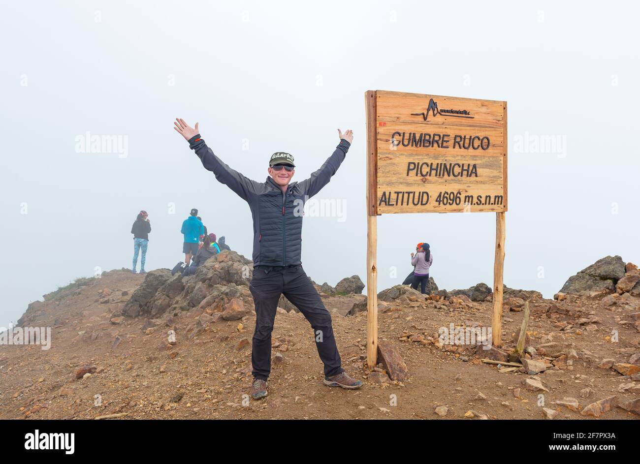 Young caucasian male in his thirties reaching the summit of the ...